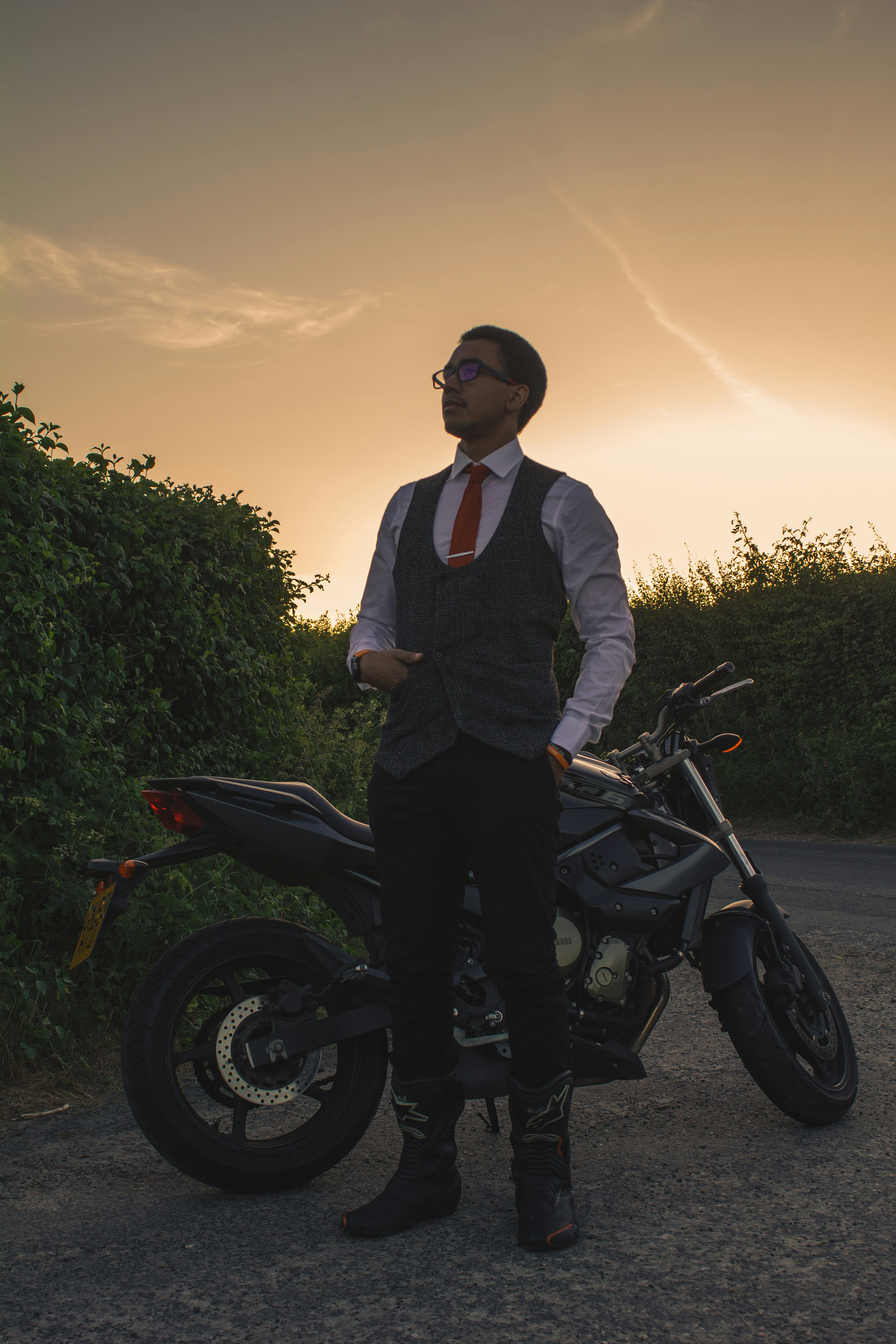 Dapper Rider by Sunset: A Quiet Moment with a Modern Motorcycle