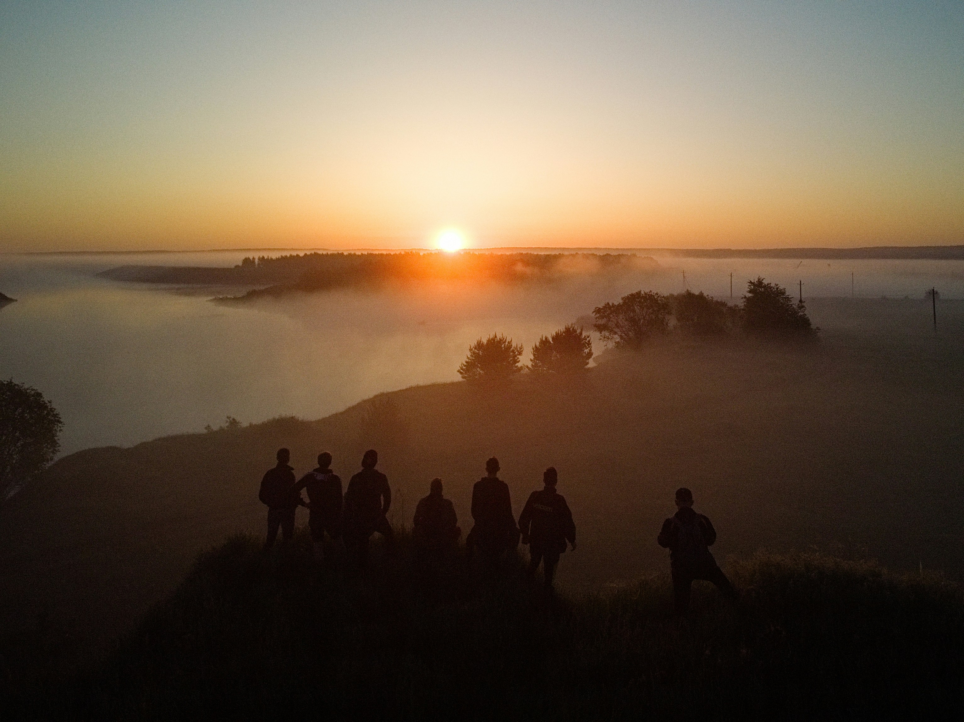 Sunrise Silhouette: A Lone Crew at the Ridge