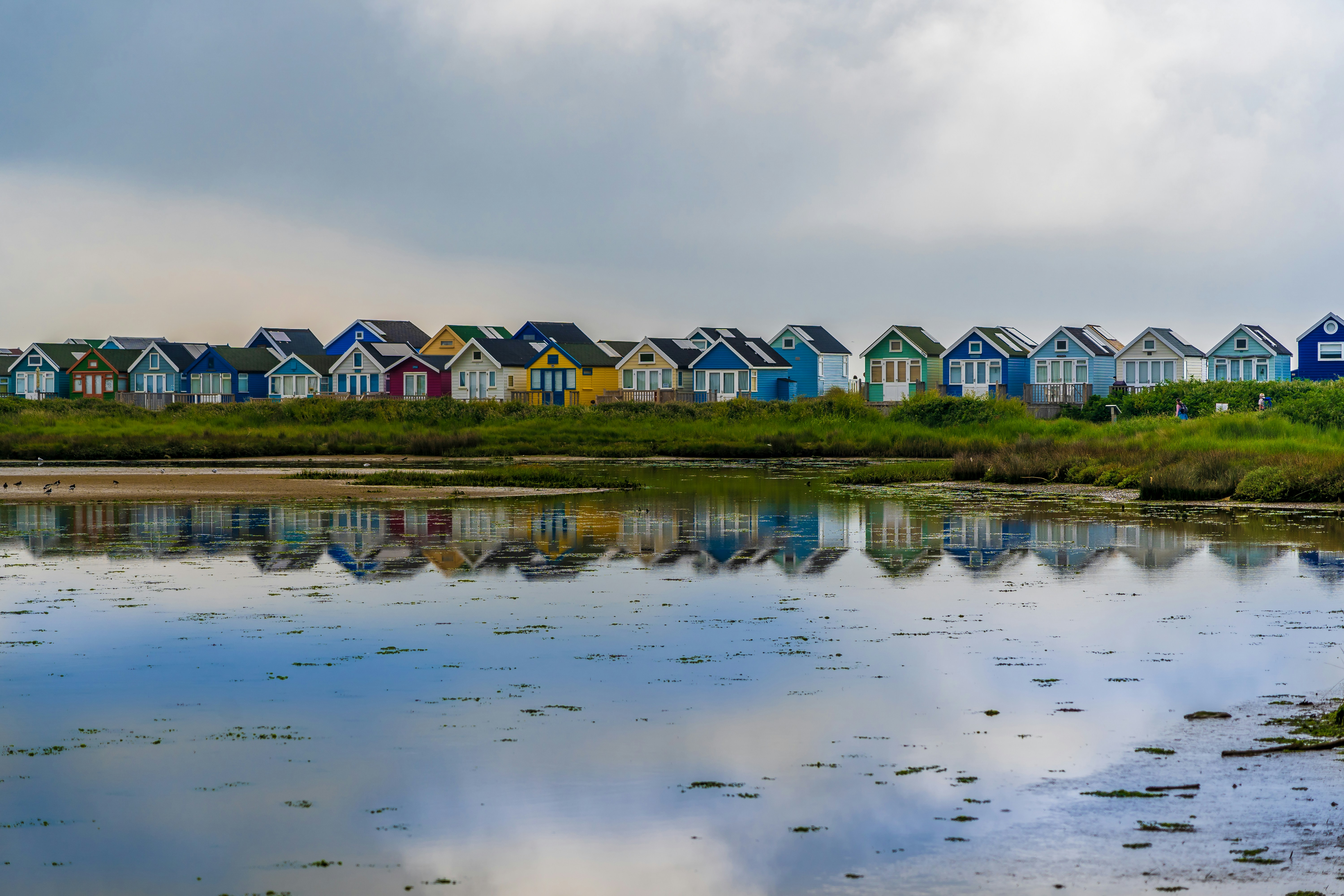 Pastel Promenade: A Row of Coastal Cottages Reflected on the Water