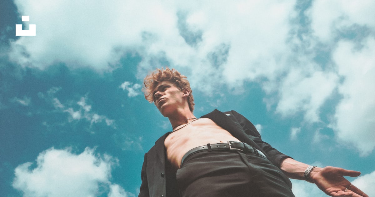 Man In Black Suit Jacket Standing Under Blue Sky During Daytime Photo
