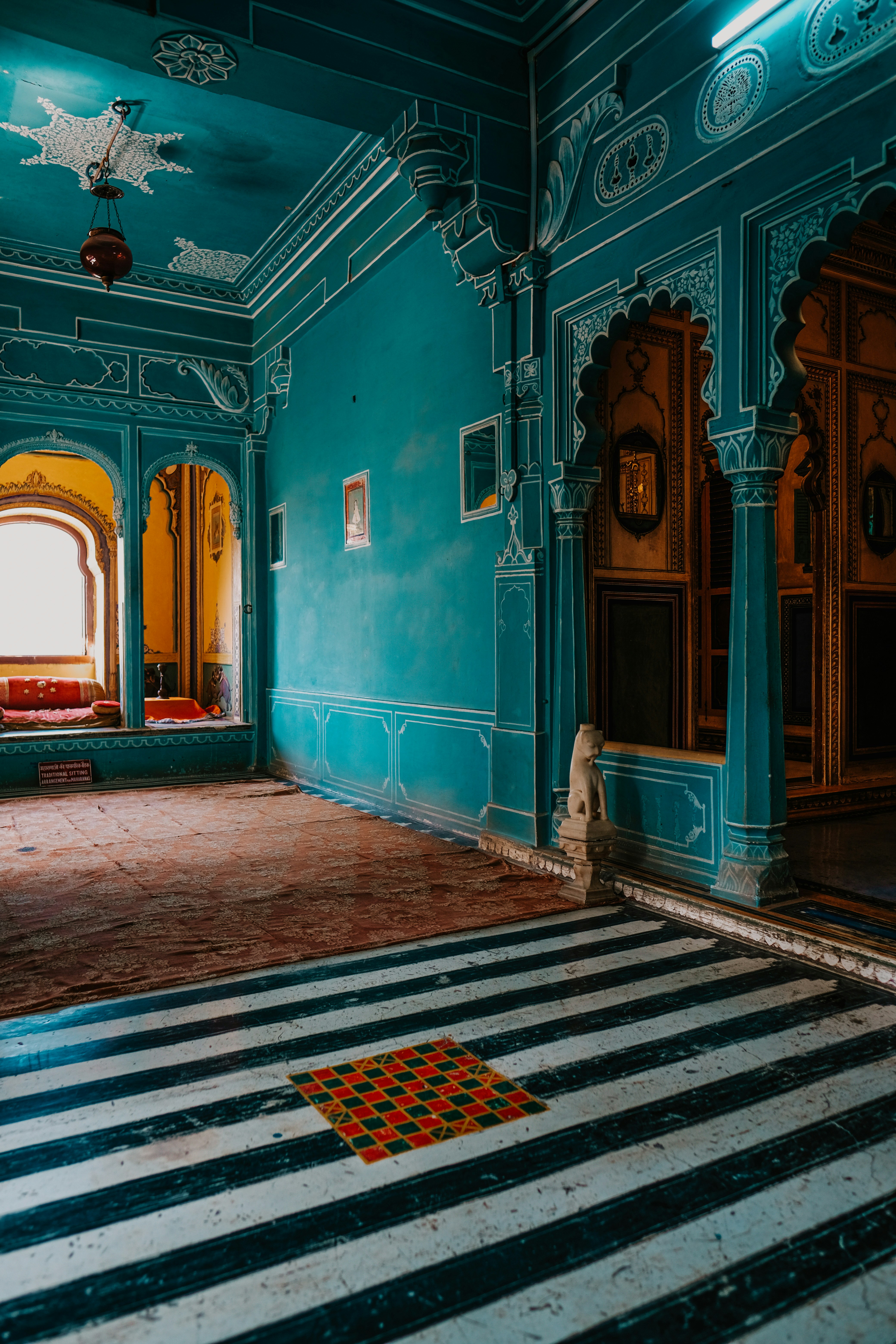 Turquoise Hall of Arches: Sunlit Niche and Striped Floor