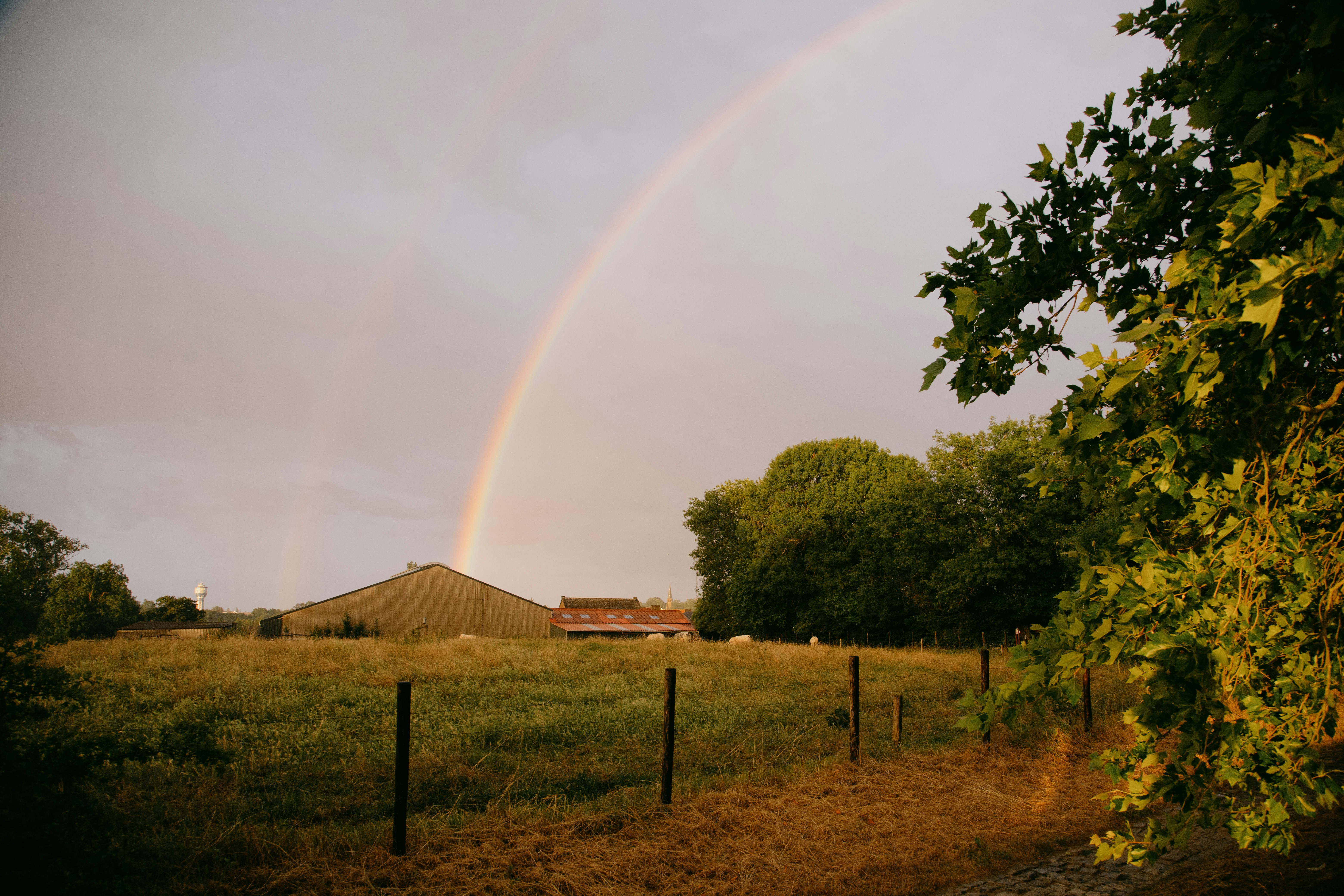 Double Arc: A Rural Rainbow Over Quiet Fields