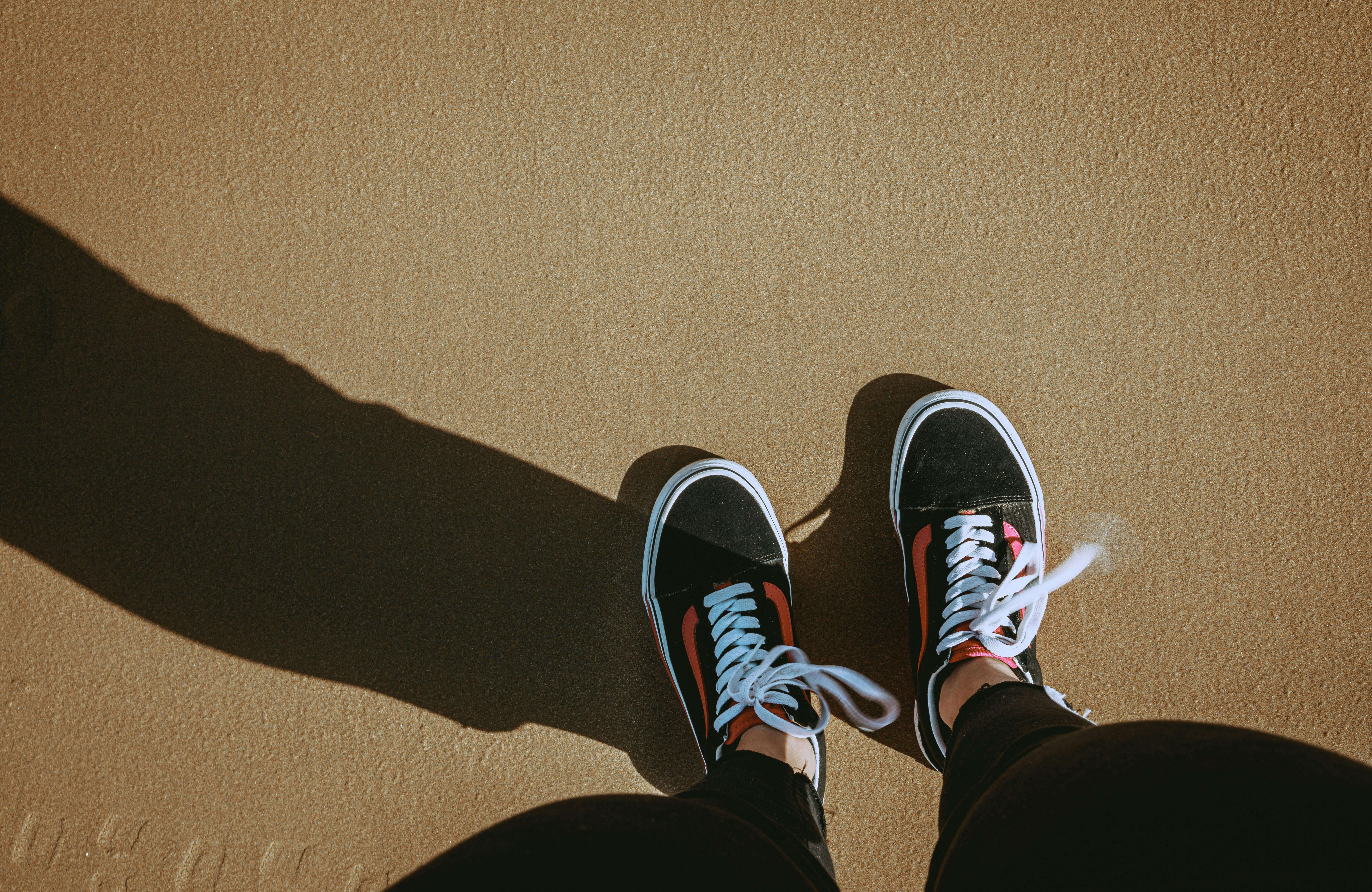 person wearing black and white sneakers