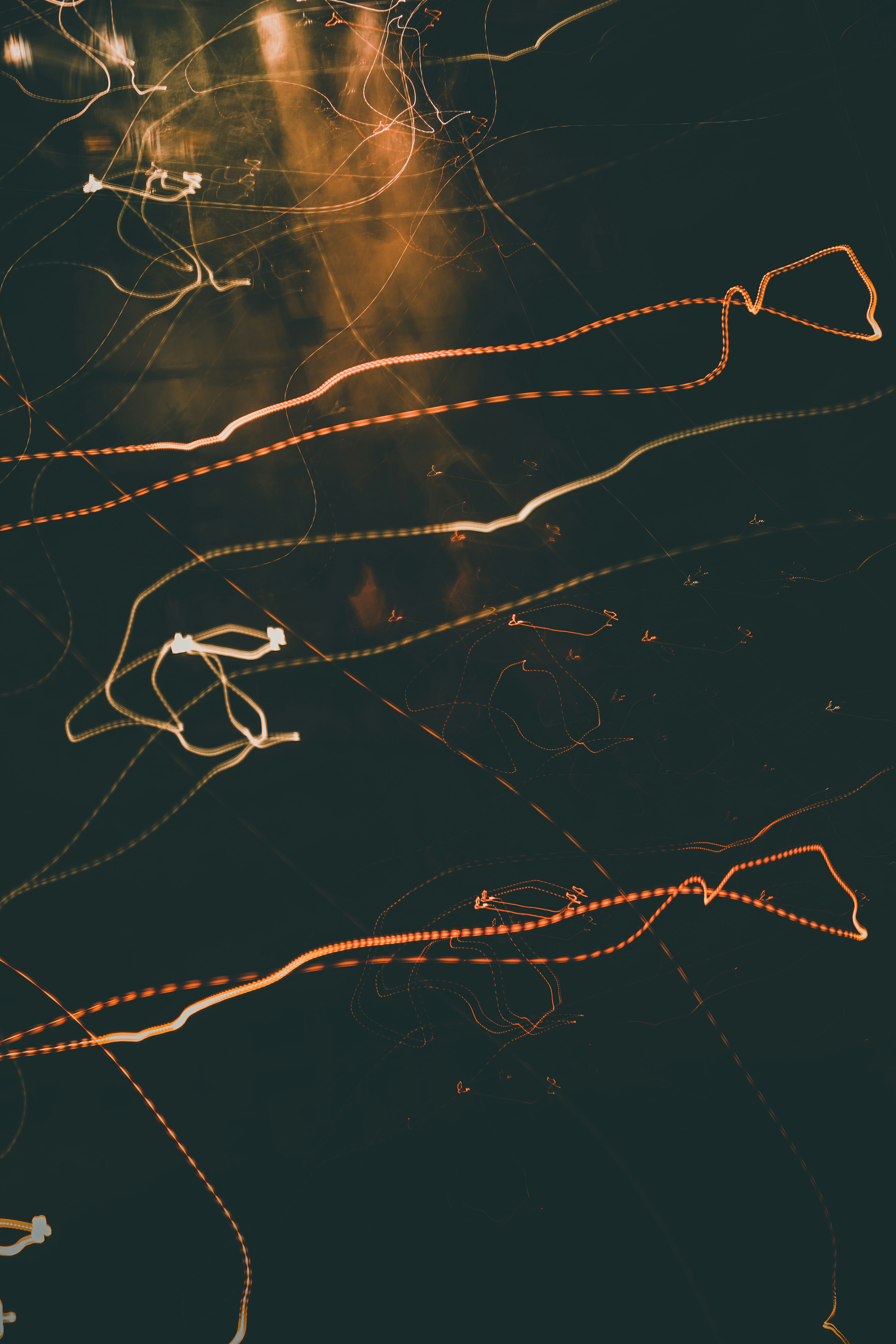 Abstract representation of dynamic light trails against a dark backdrop, showcasing movement and energy.