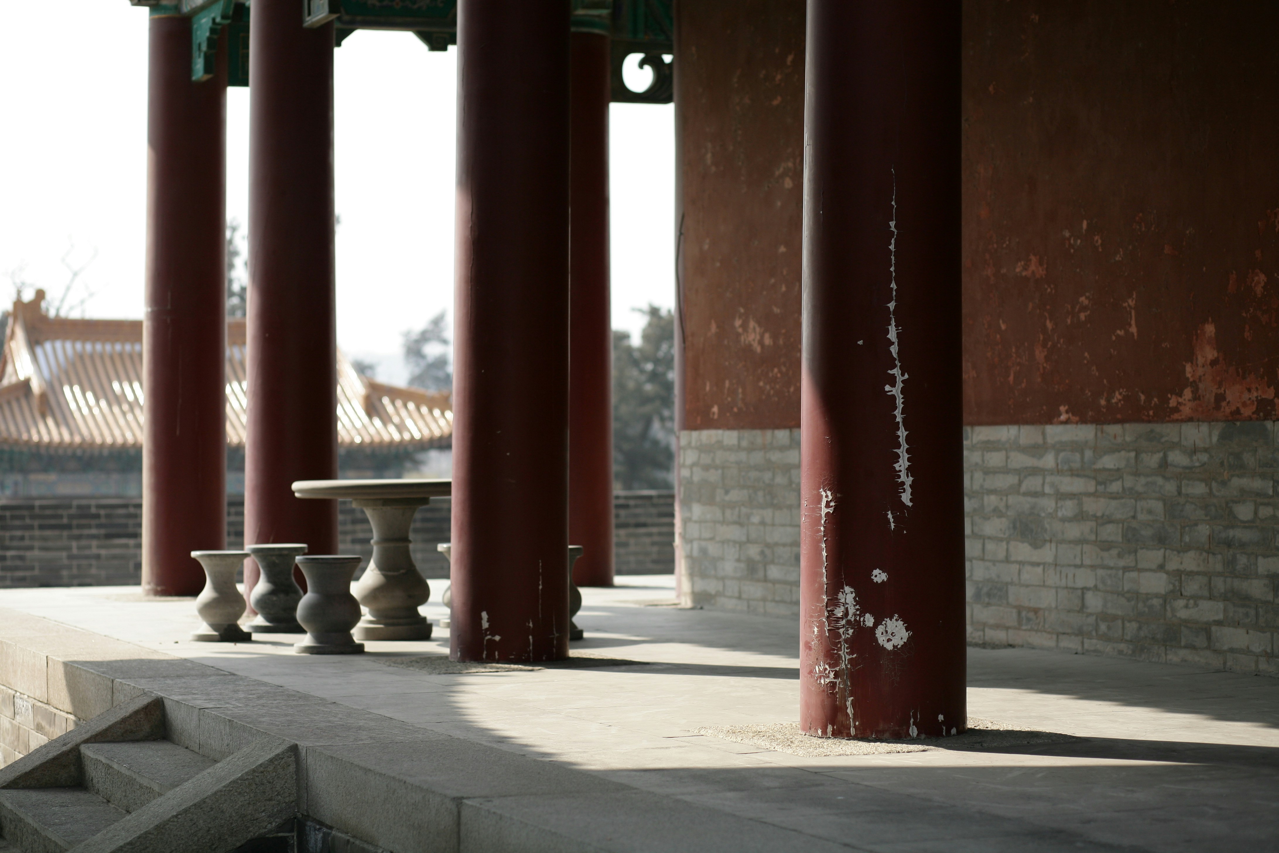 Red Pillars Framing a Quiet Courtyard Terrace