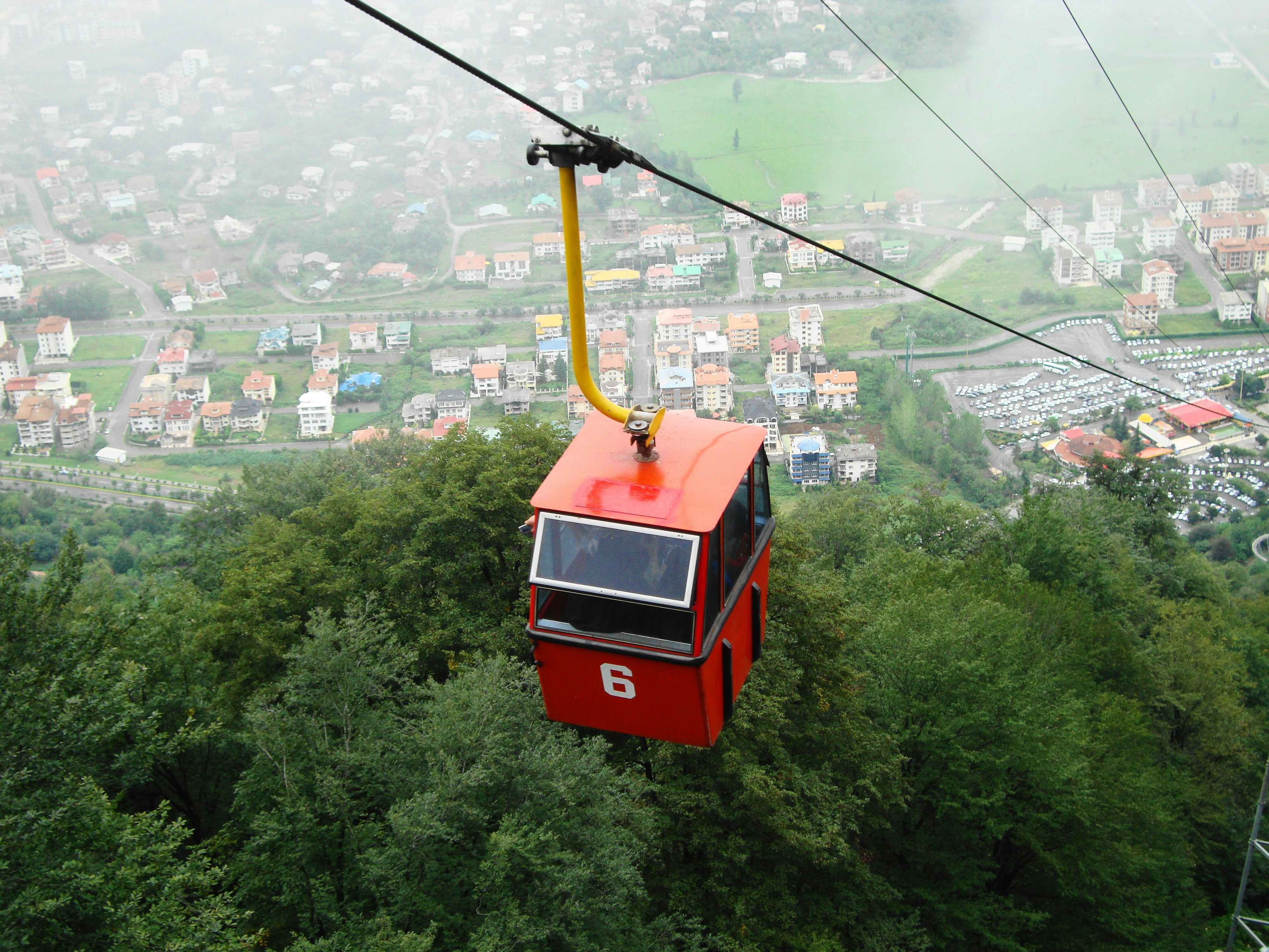 Red cable car over city buildings during daytime photo – Free Iran ...