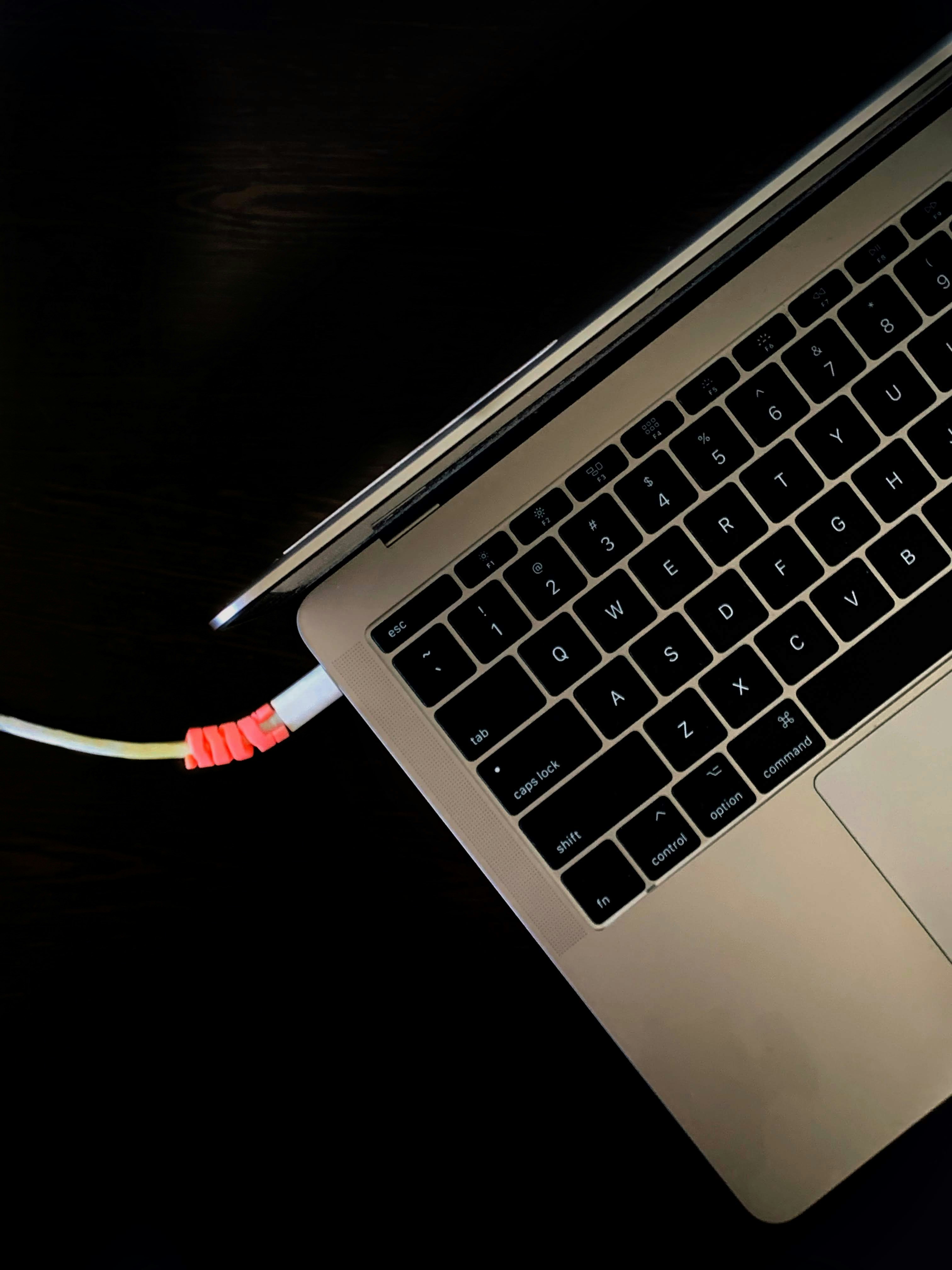 Midnight Charge: MacBook Edge Meets a Wrapped Cable