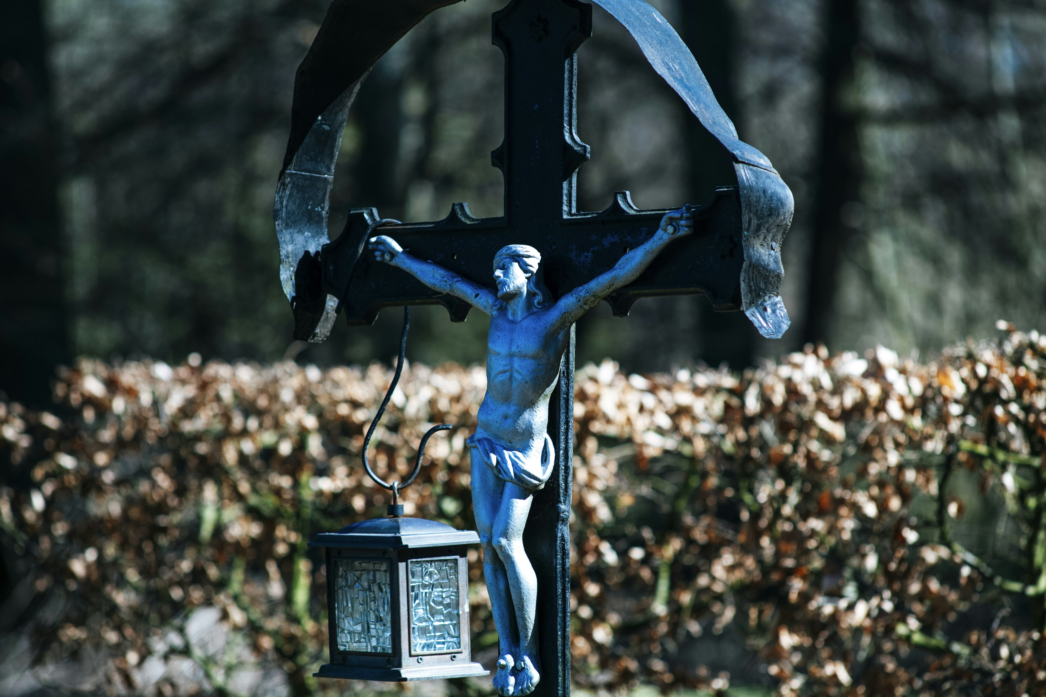 Azure Crucifix in a Lantern-lit Garden