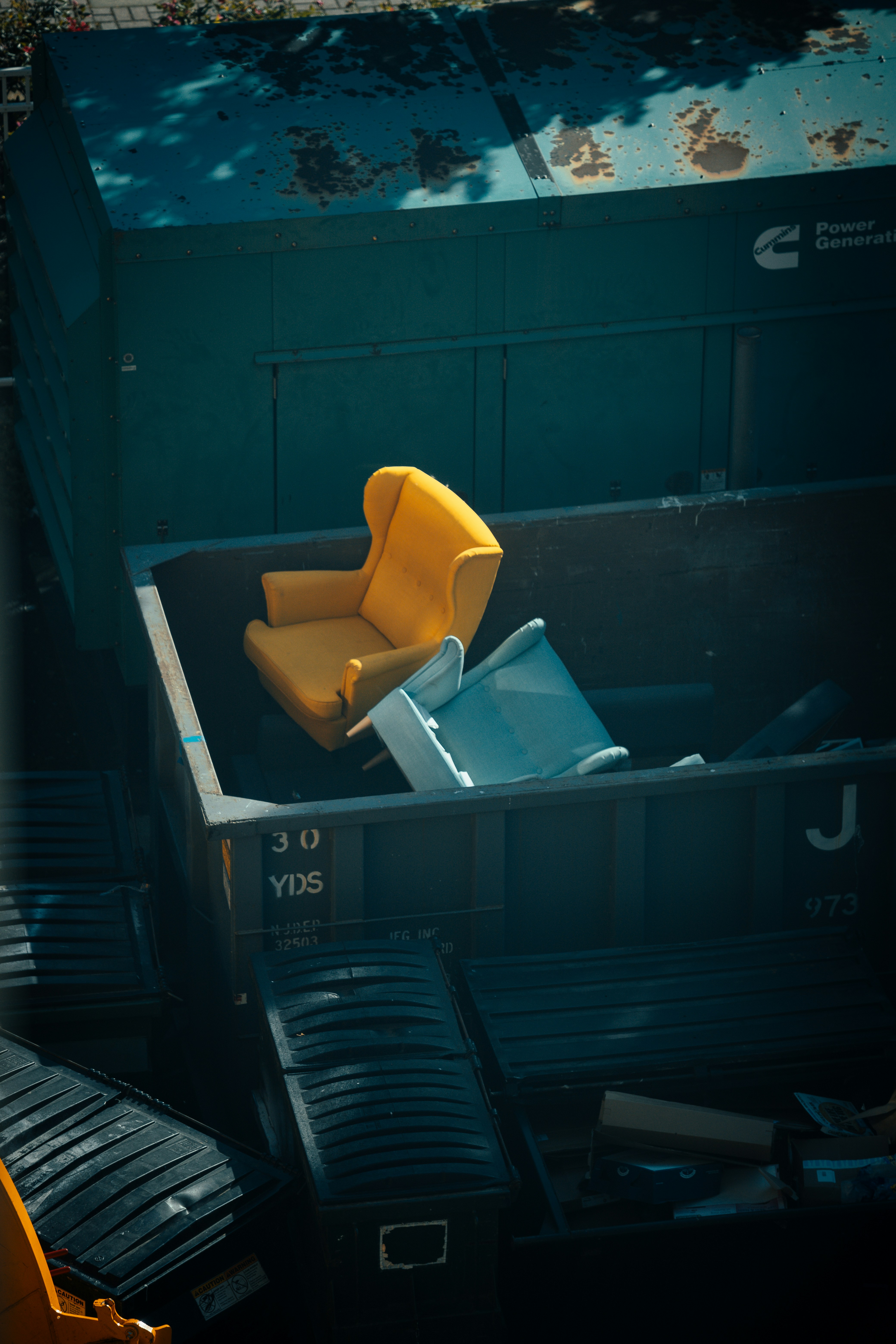 Sunlit Yellow Armchair Rising From a Dumpster Bluescape