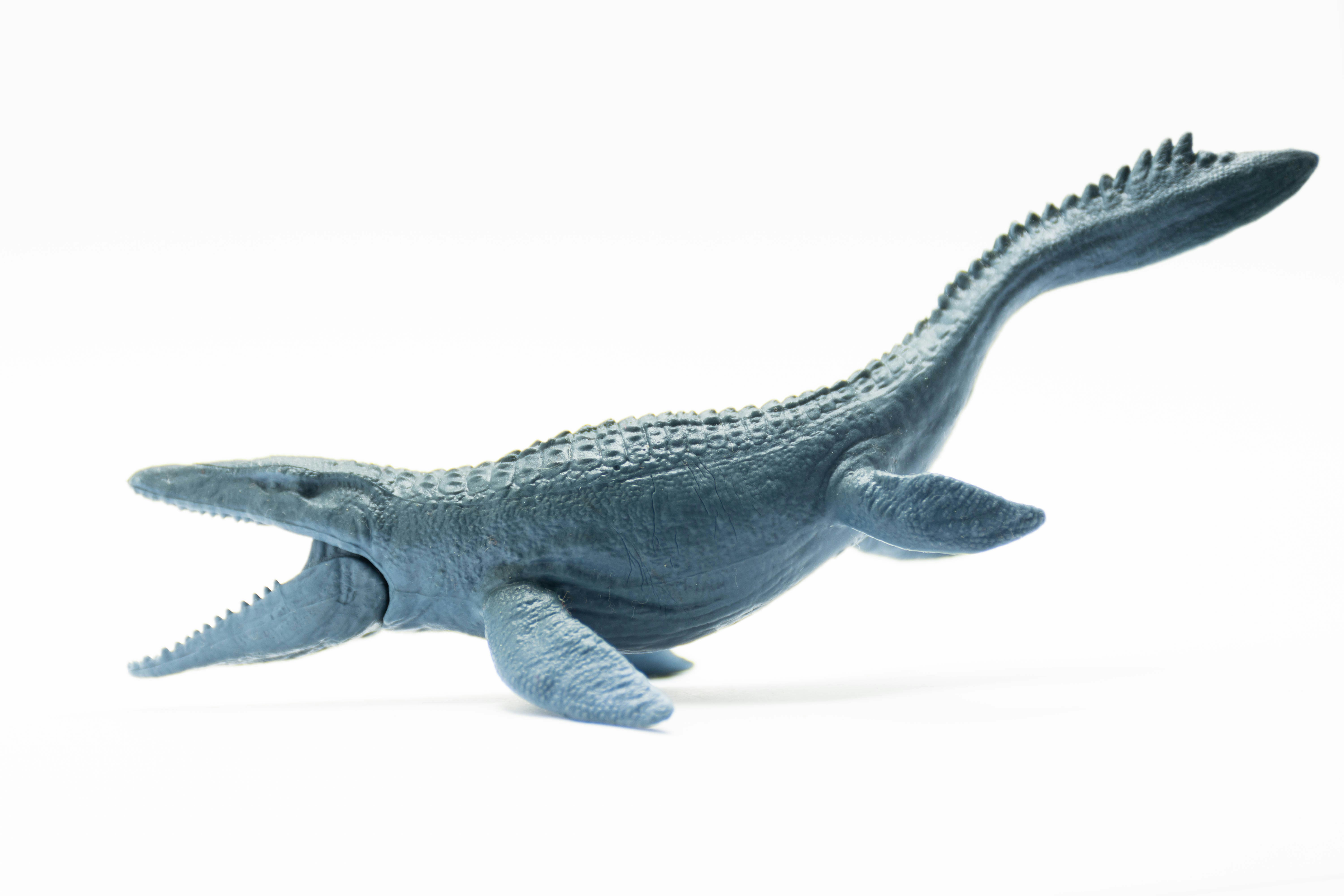 Toothy Behemoth on White: an off‑white toy crocodile defies gravity in a stark studio
