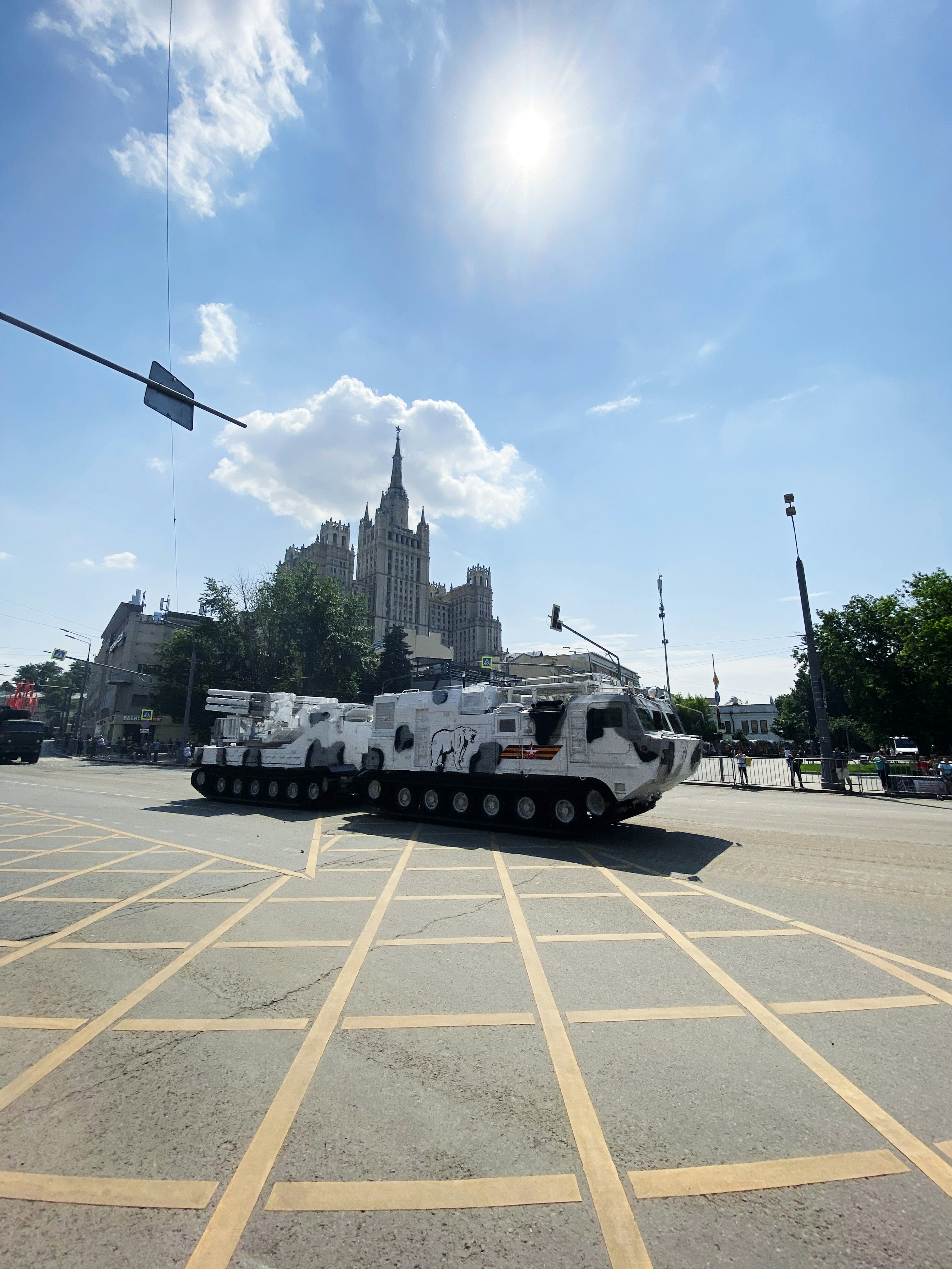 Sunlit Armored Convoy in a Historic City Square
