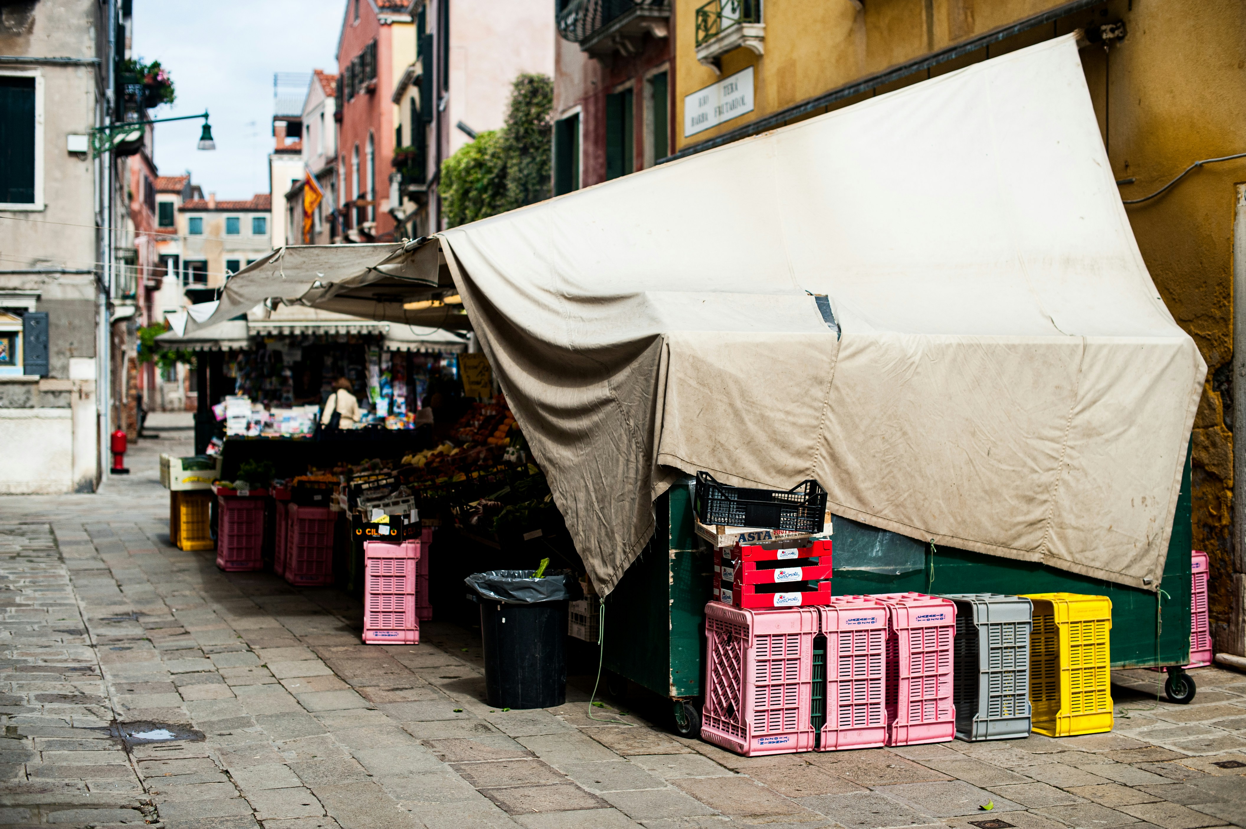 Cream Canopy Market: A Sunlit Corridor of Crates and Color