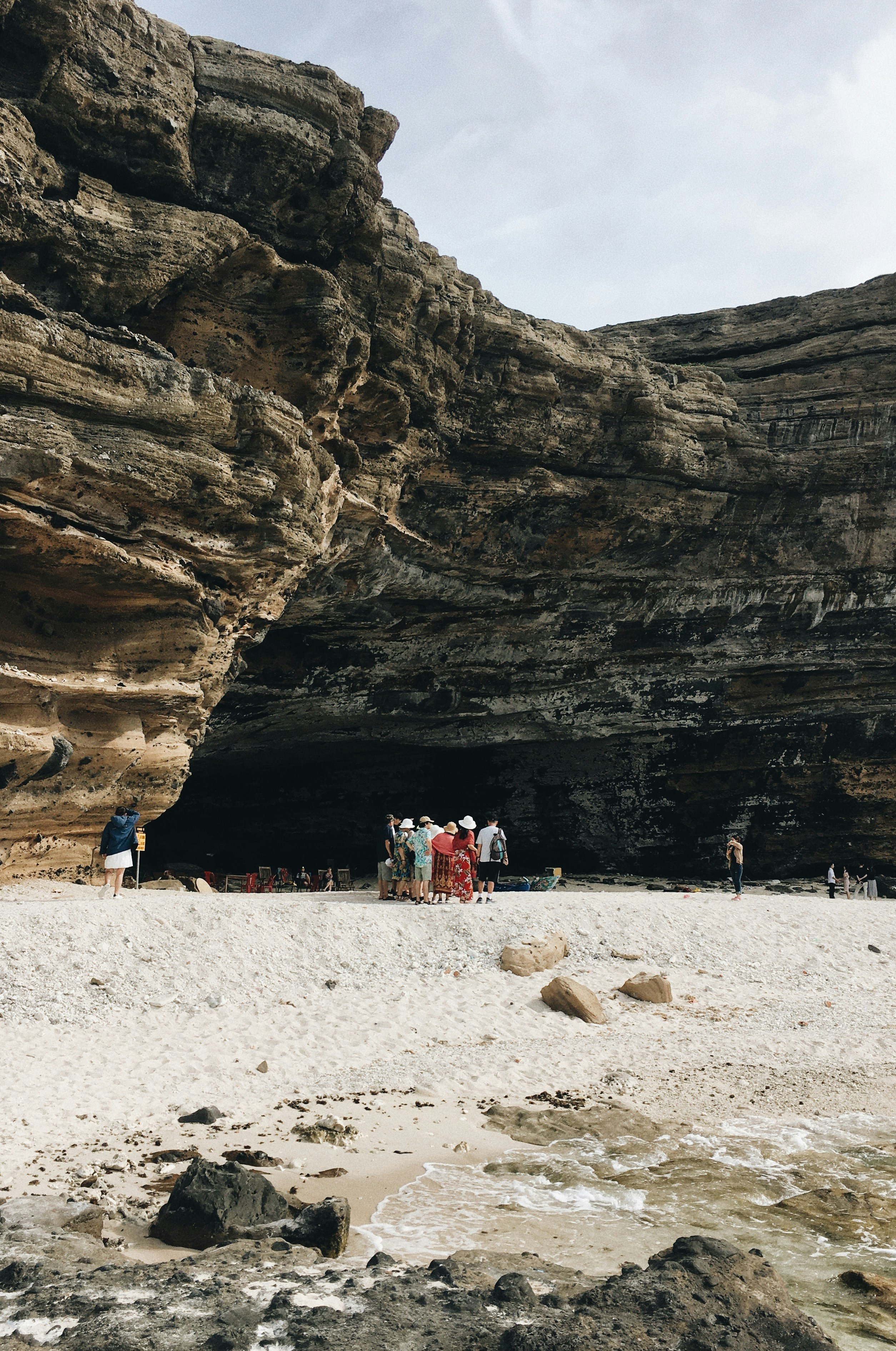 Grotto Gathering on a Sunlit Shore