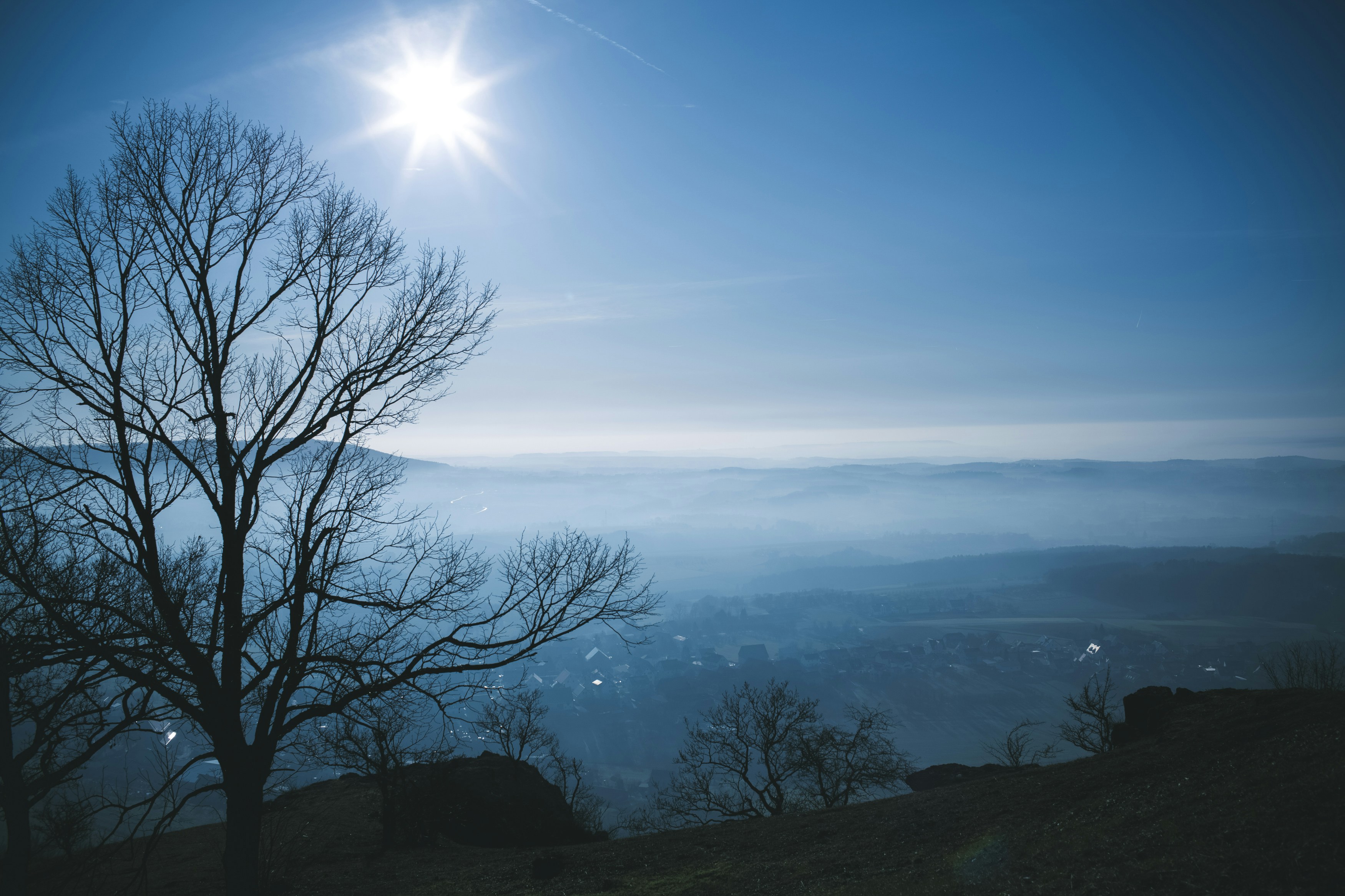 Winter valley haze under a sapphire sky