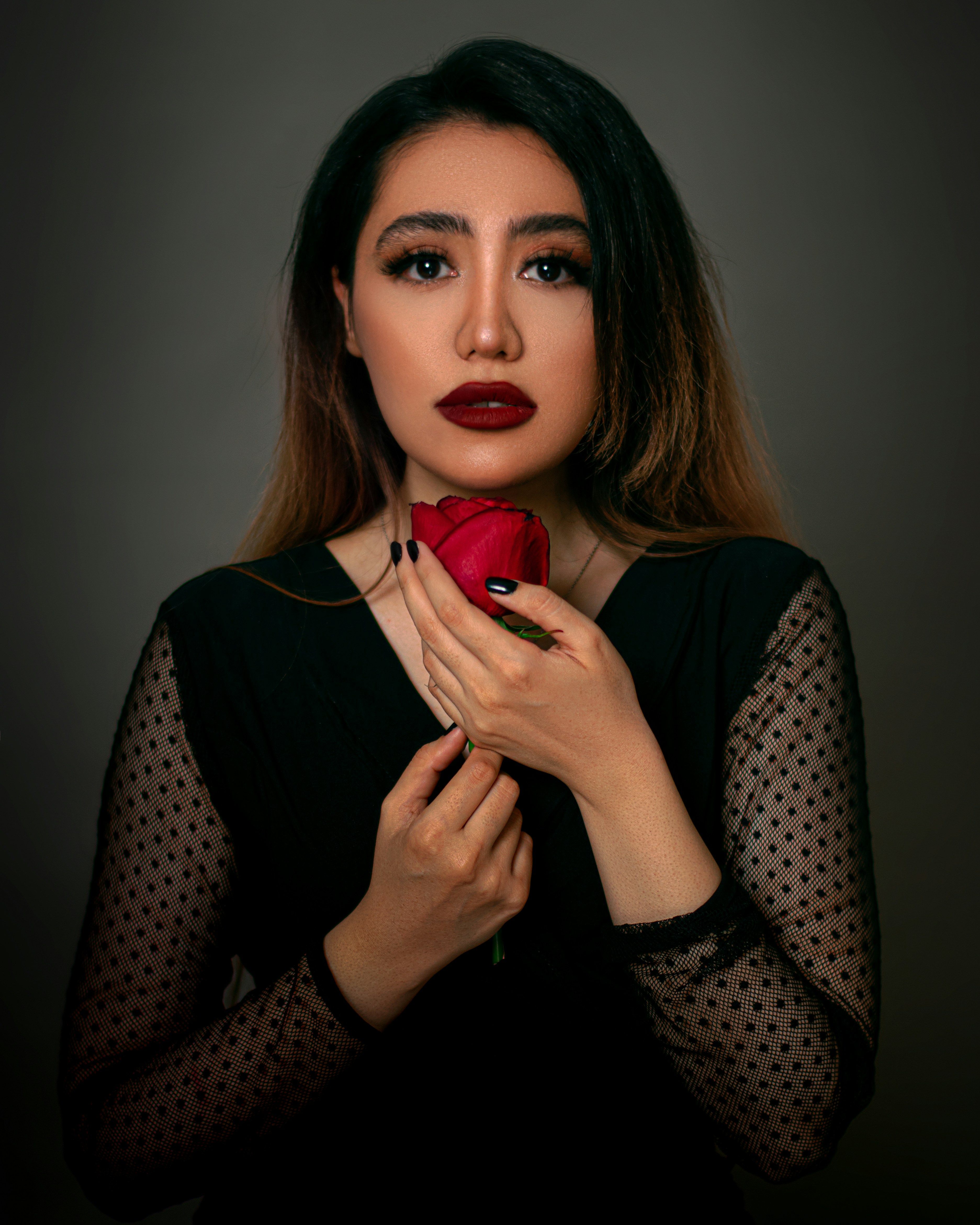 Woman in black long sleeve shirt holding red rose photo – Free Iran ...