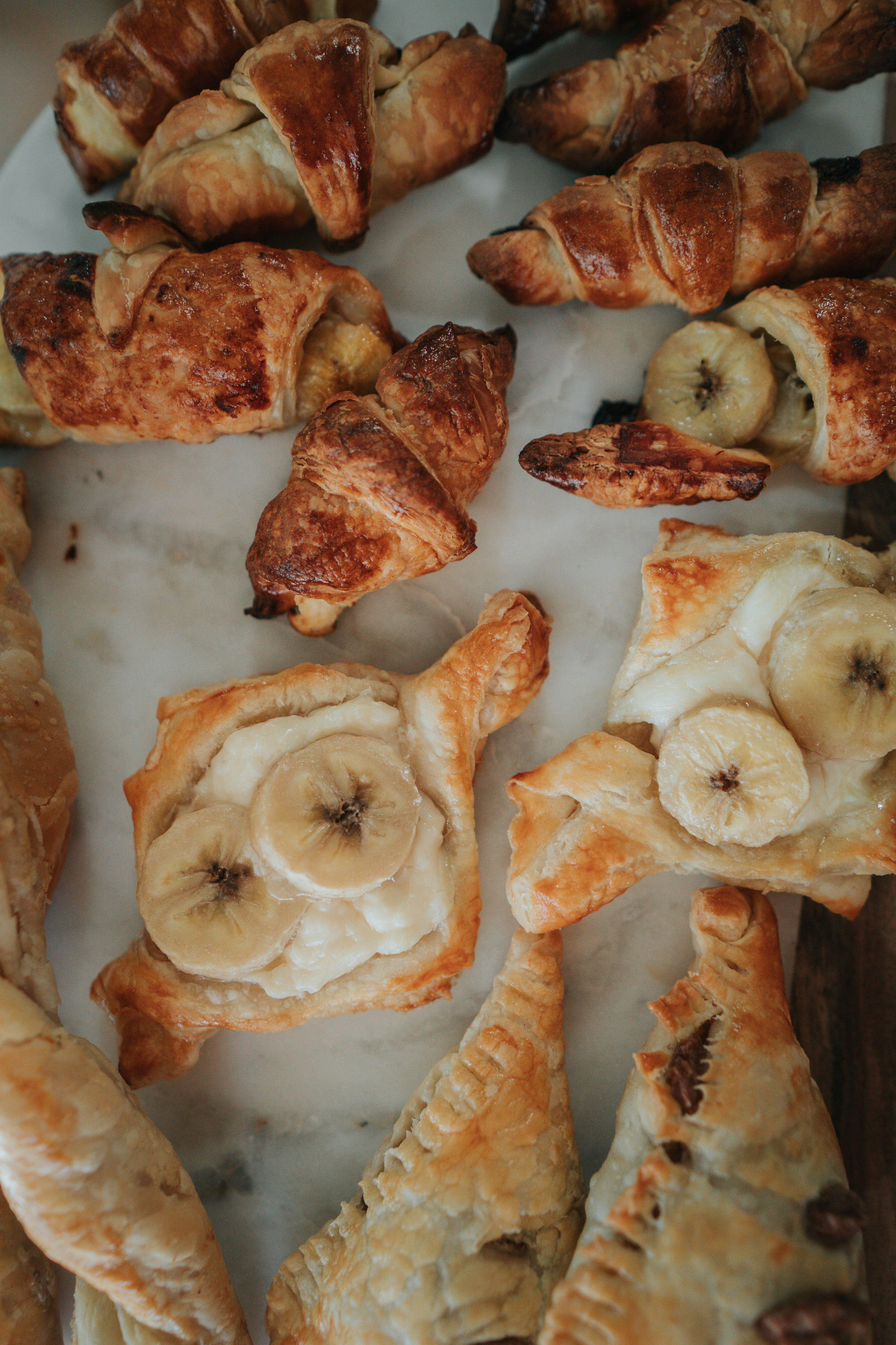 Banana-Glazed Pastry Medley on Marble Surface