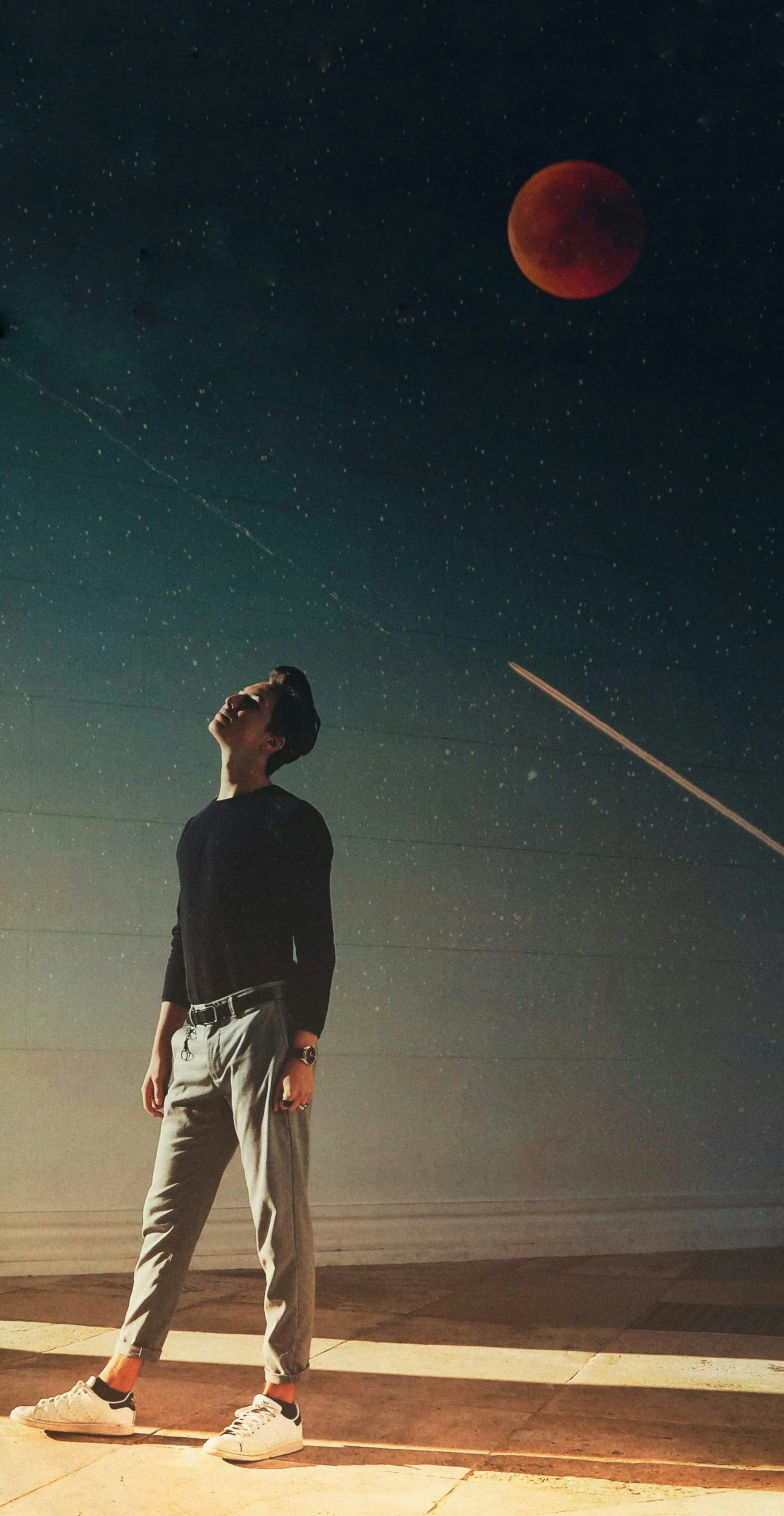 Red Moon, Quiet Stance: Night Portrait Under a Starry Sky