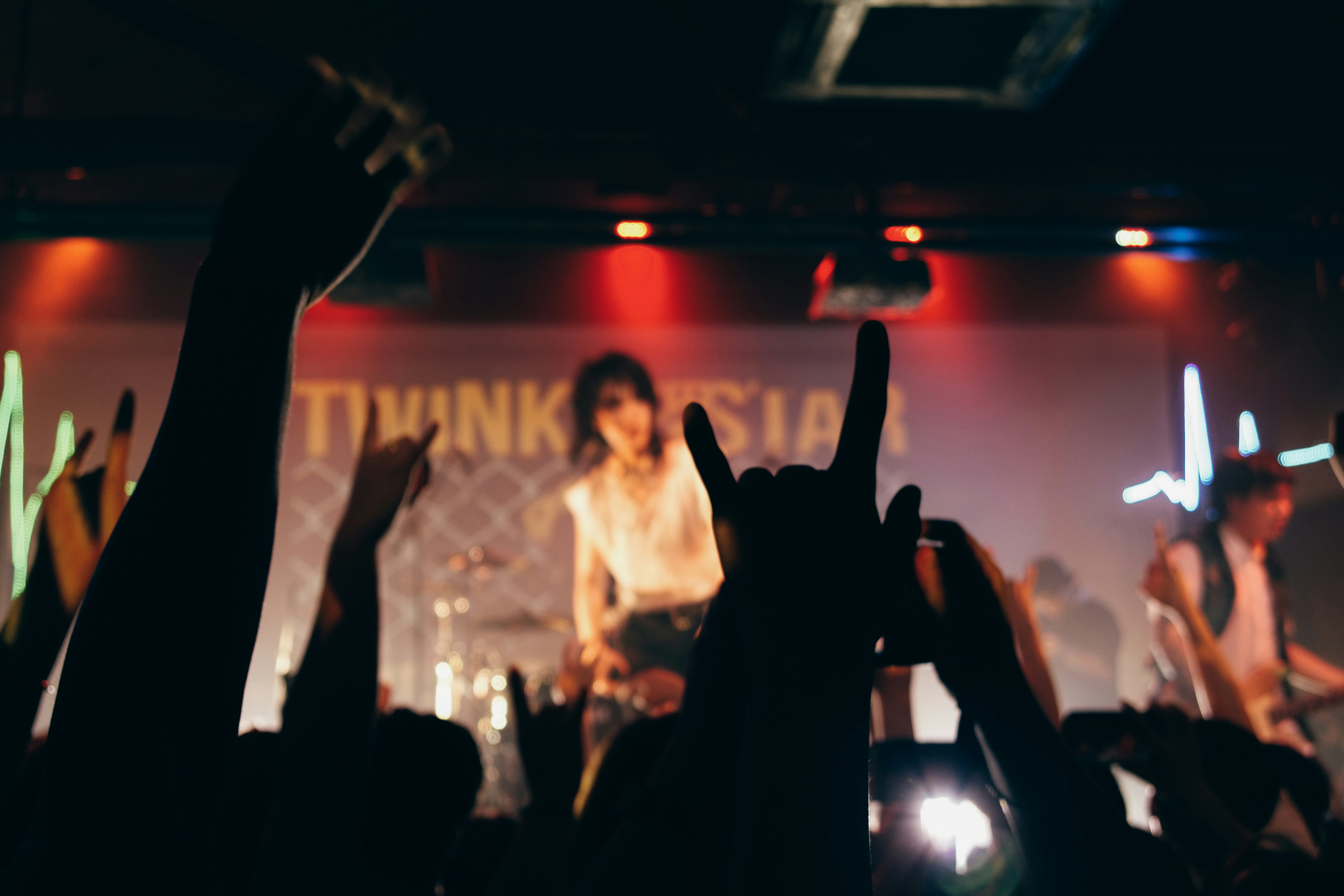 People raising their hands in front of a stage photo – Free Human Image ...