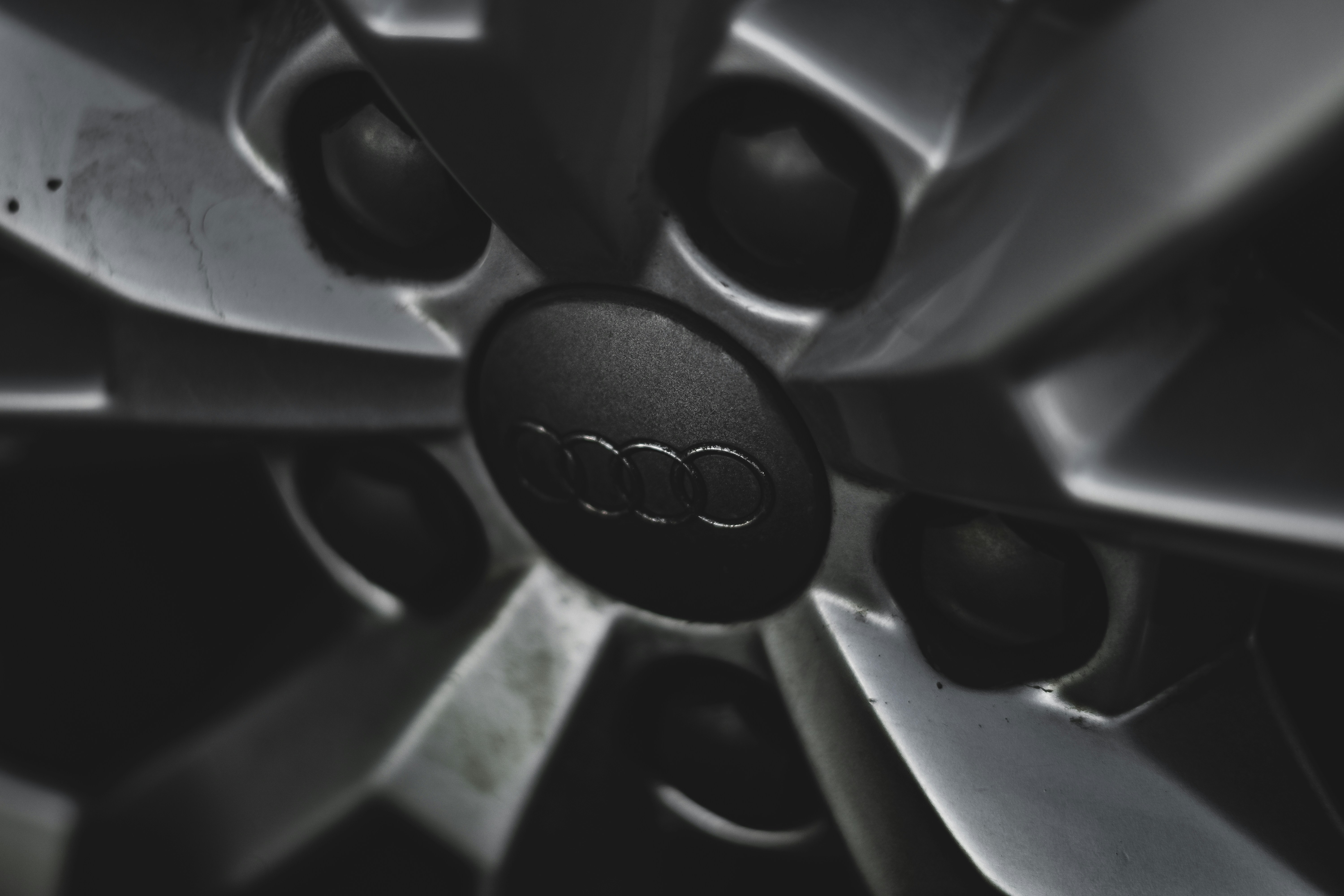 Centered Audi Wheel Cap: A Macro Portrait of Emblem and Spokes