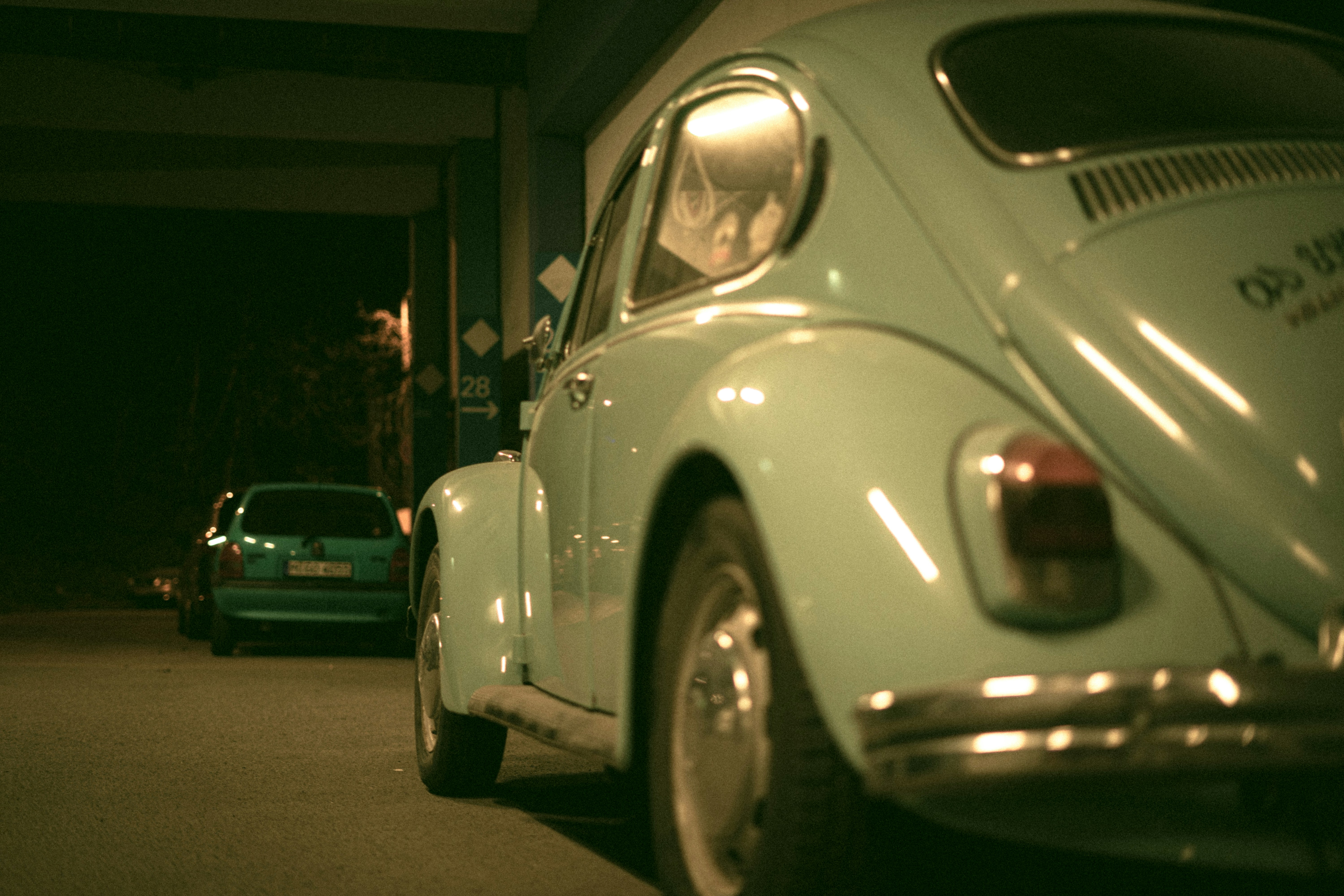 Moonlit Parking: A Row of Vintage Beetles Under Neon Night