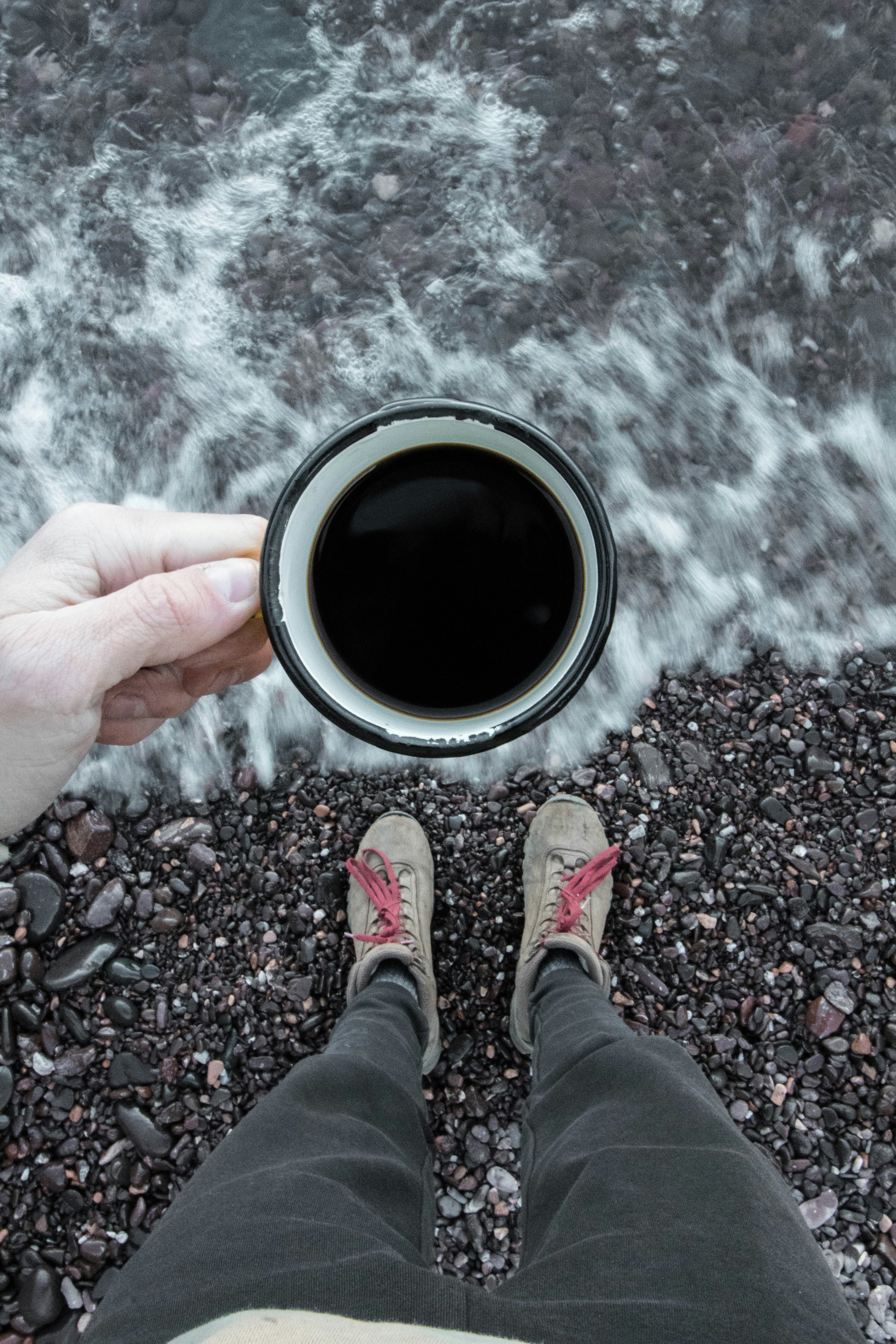 Cup Over Currents: A Pause by the Pebble Shore