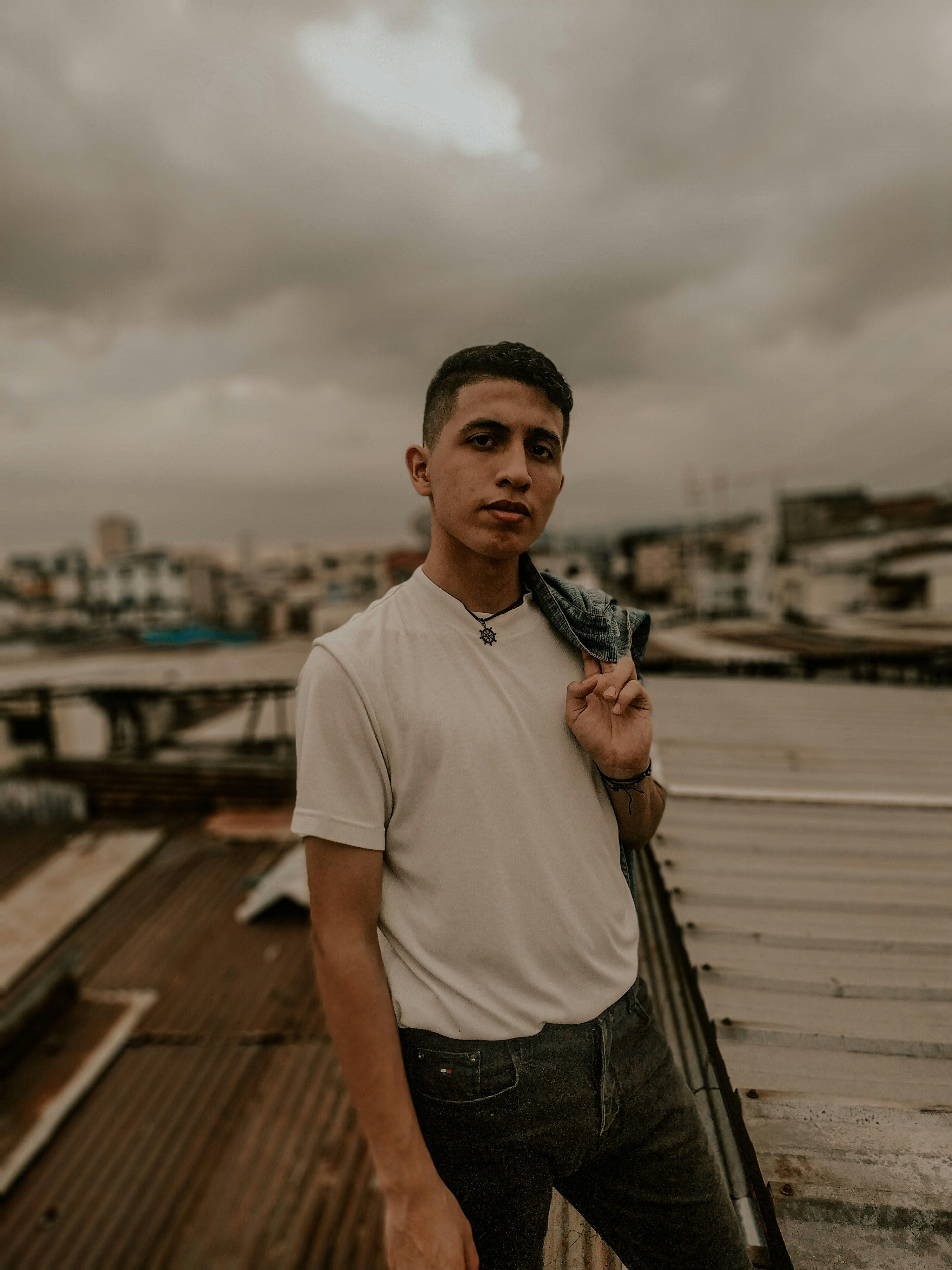 Rooftop Portrait: A Quiet Gaze Over a Distant City