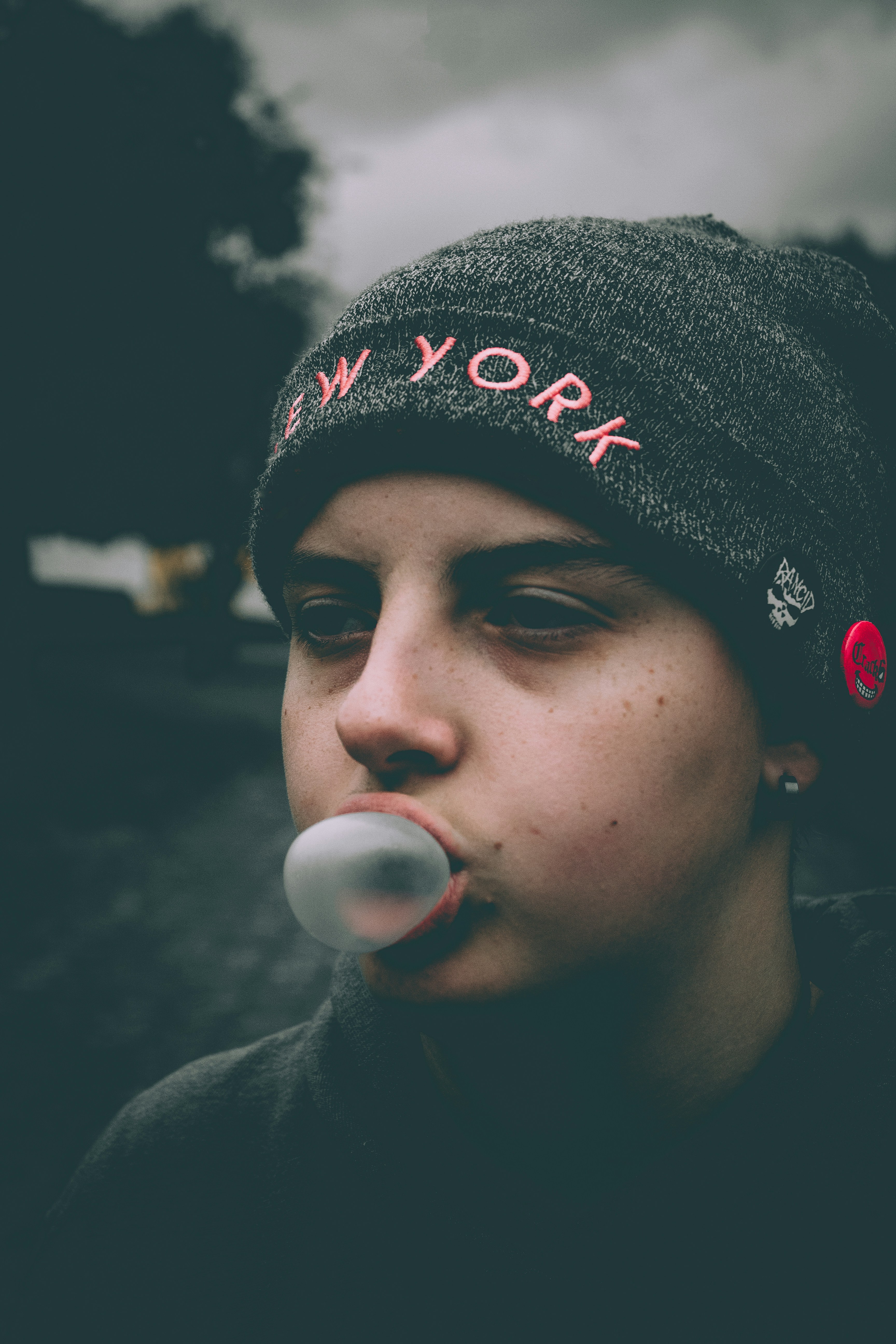 Bubble and Beanie: A Moody Portrait Under Cloudy Light
