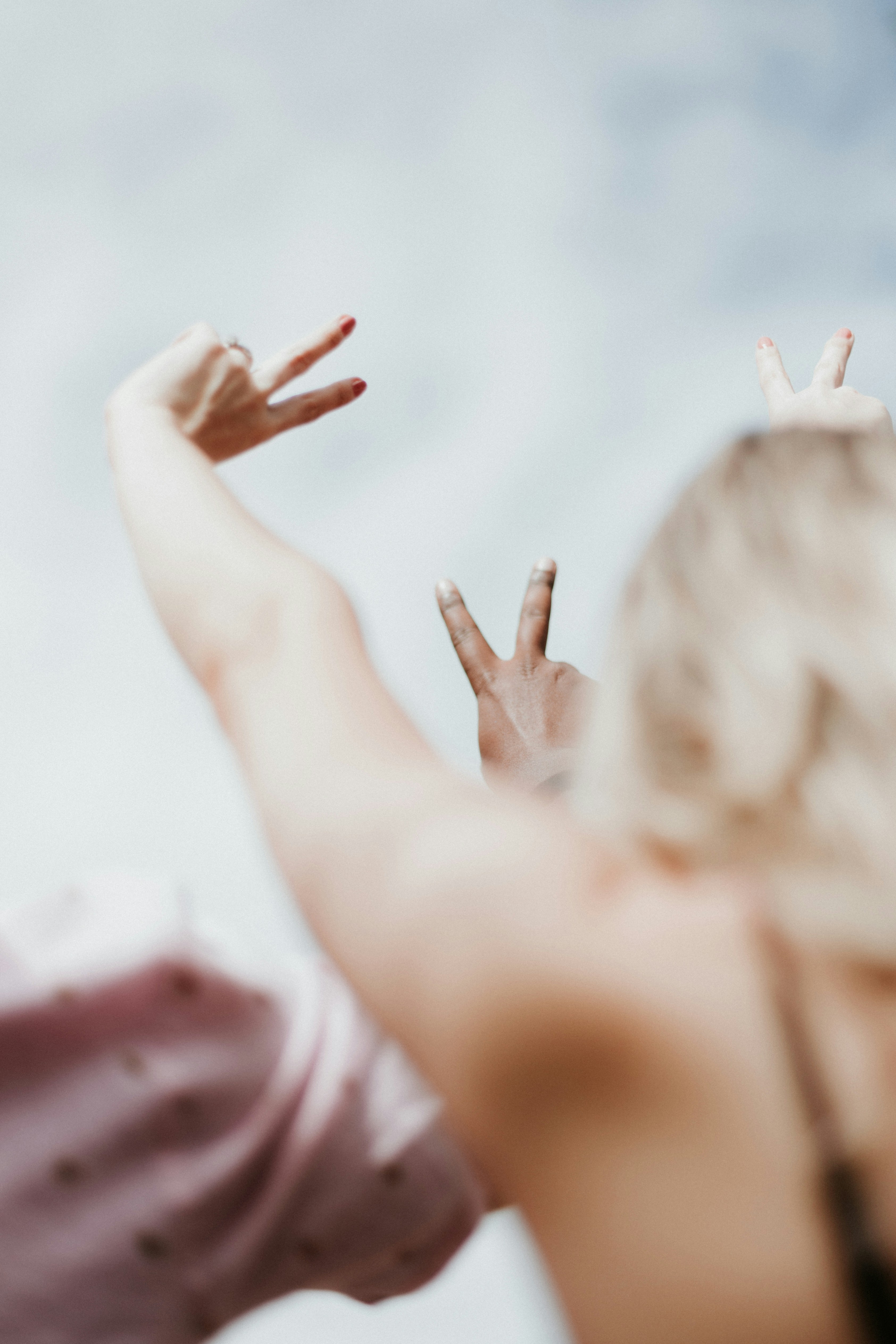 Skyward Gestures: A Soft-Focus Portrait of Reaching Hands