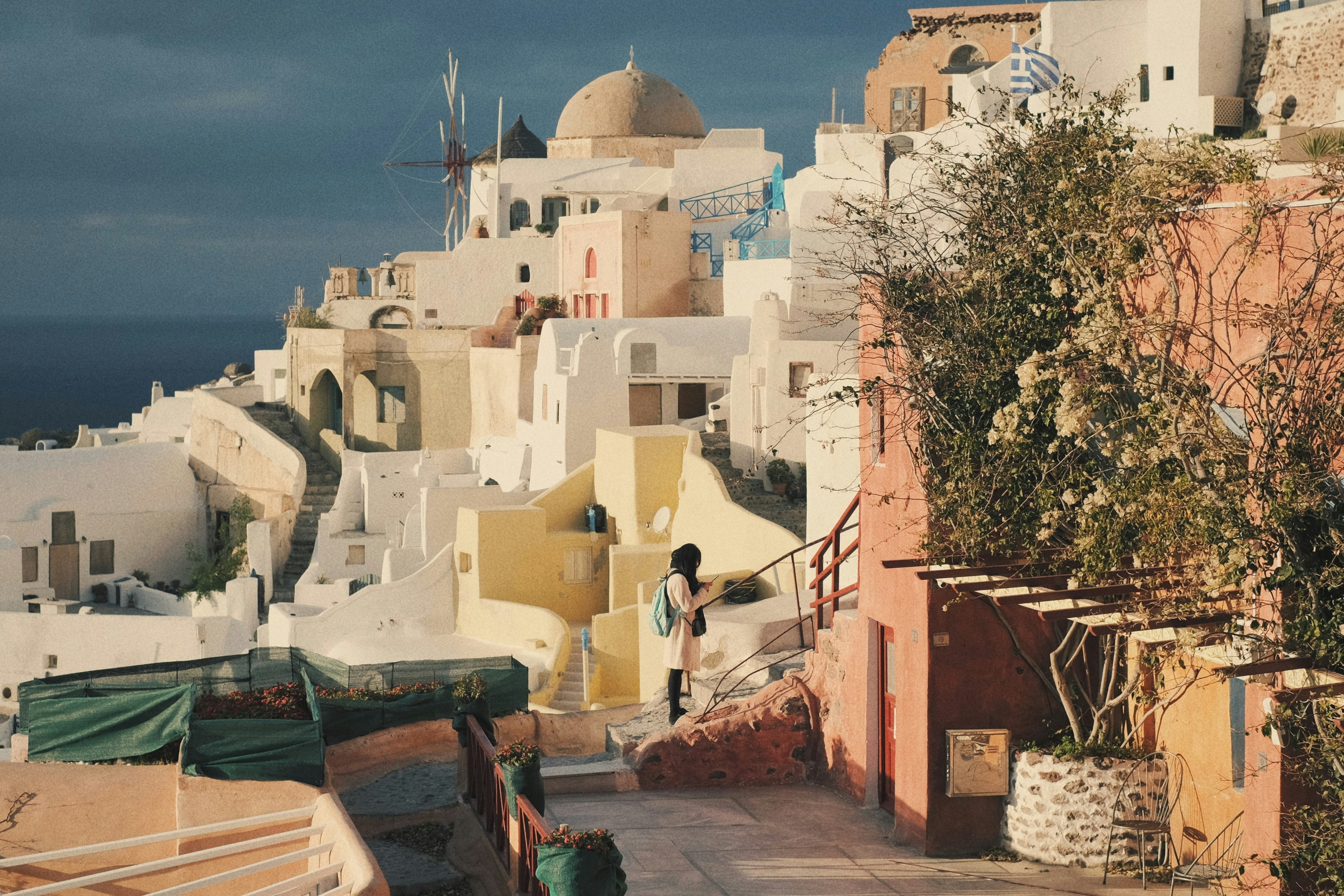 Solitary Wanderer on Sunlit Cycladic Steps