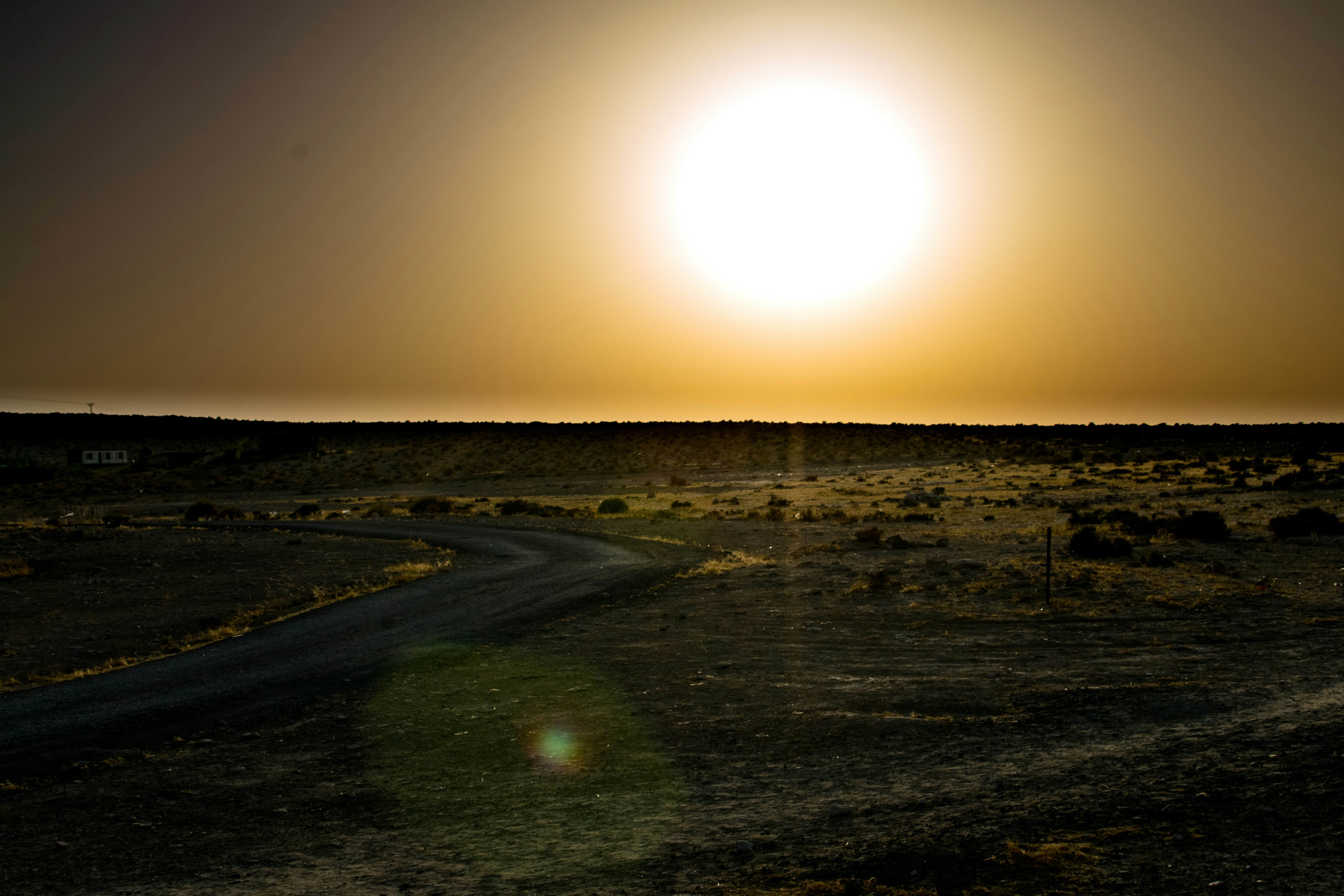 Desert Dusk: A Winding Road Toward a Blazing Horizon