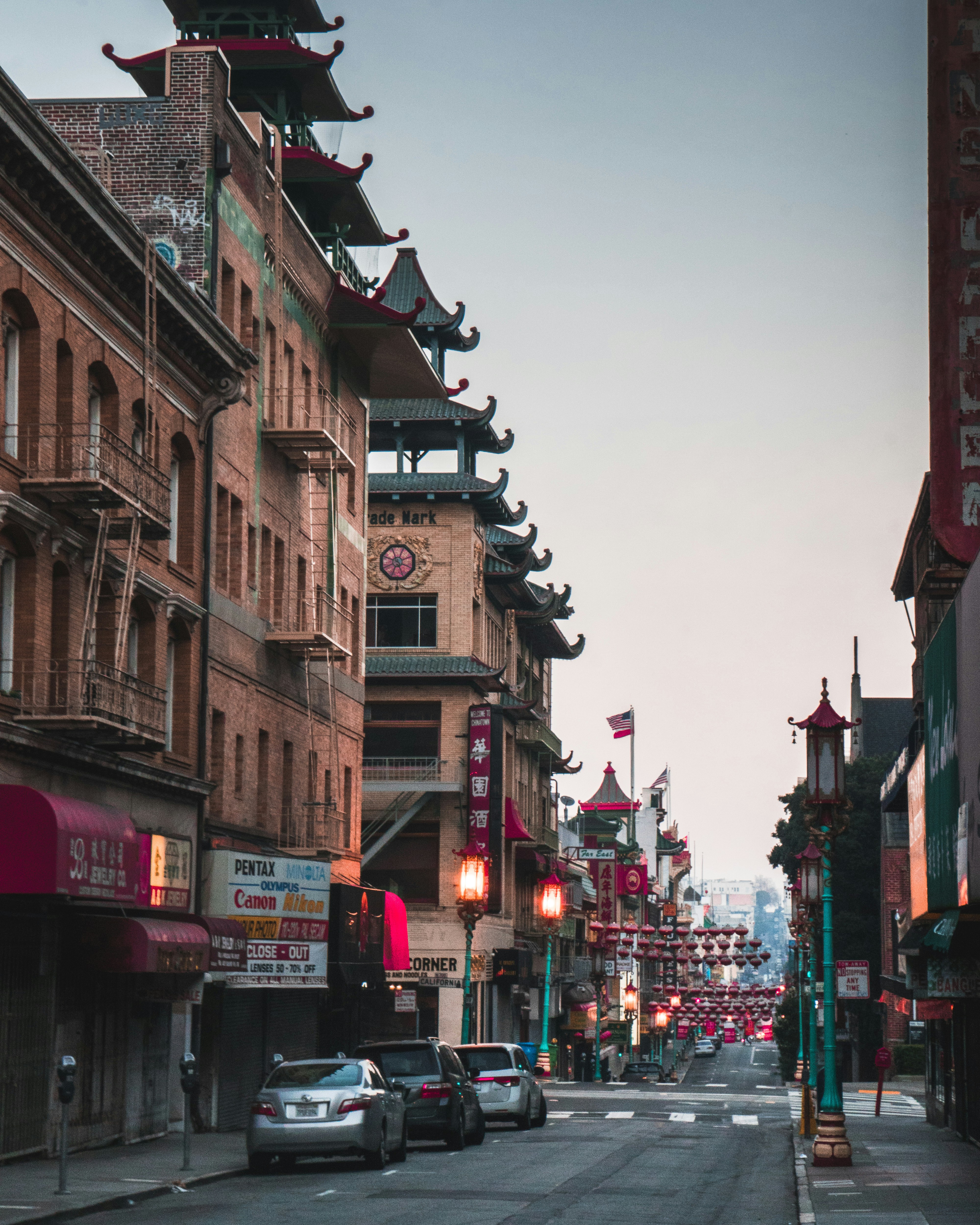 Charming street view in a historic Chinatown, showcasing traditional architecture and vibrant lanterns lining the path.