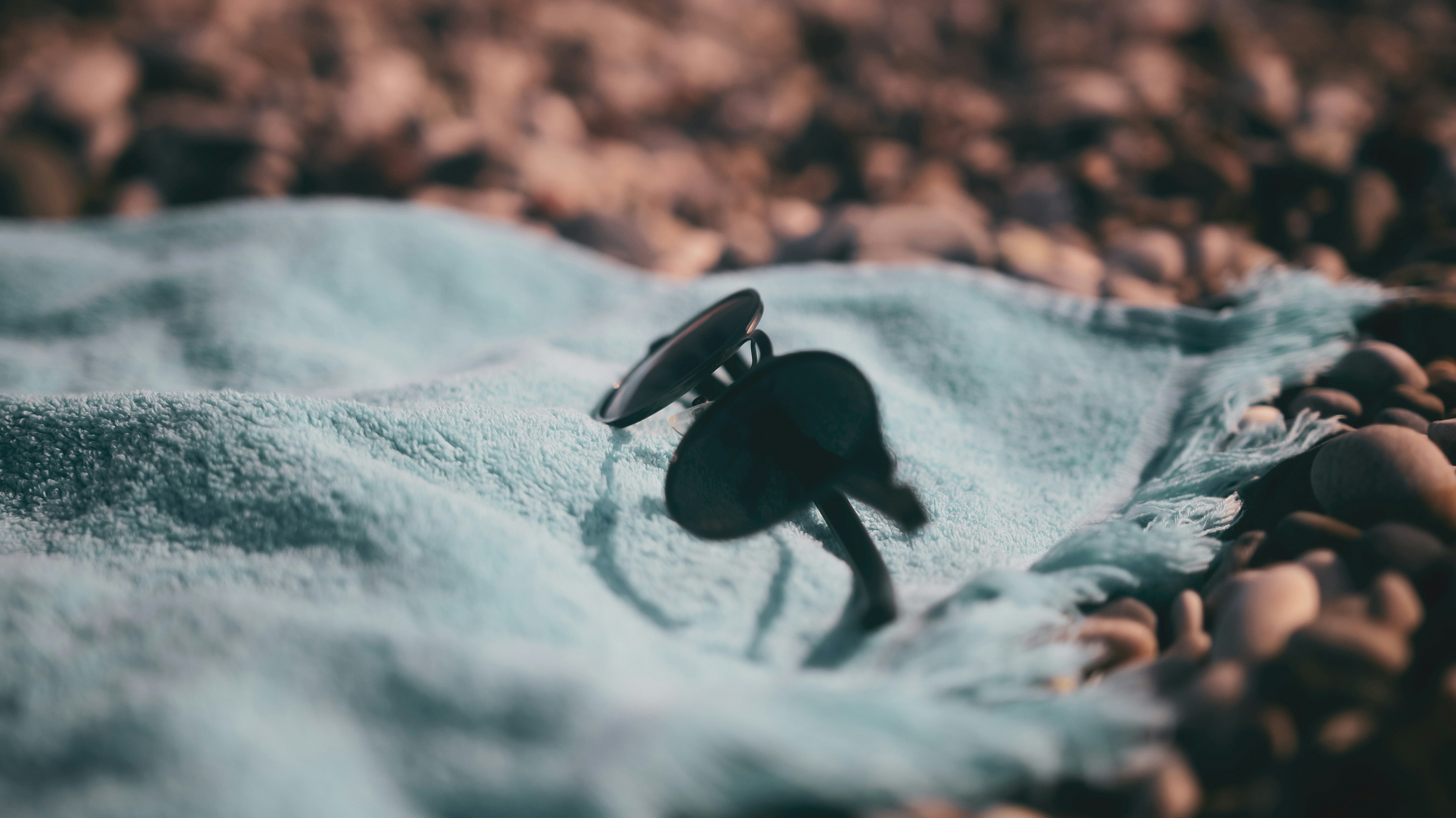 A tiny umbrella in a sea of pebbles and soft fabric