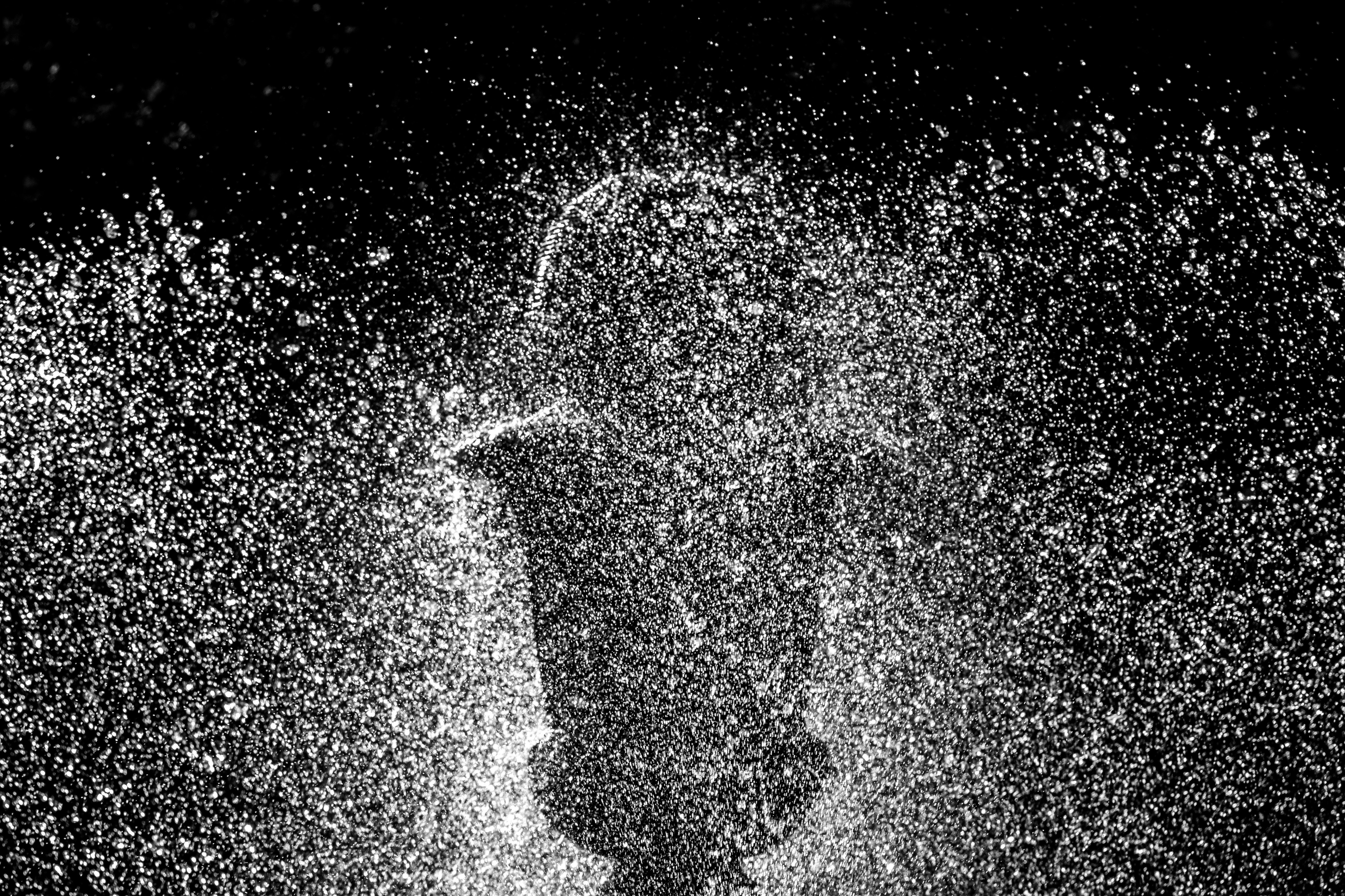 Shadow in the Spray: A Silhouette Amid Midnight Mist