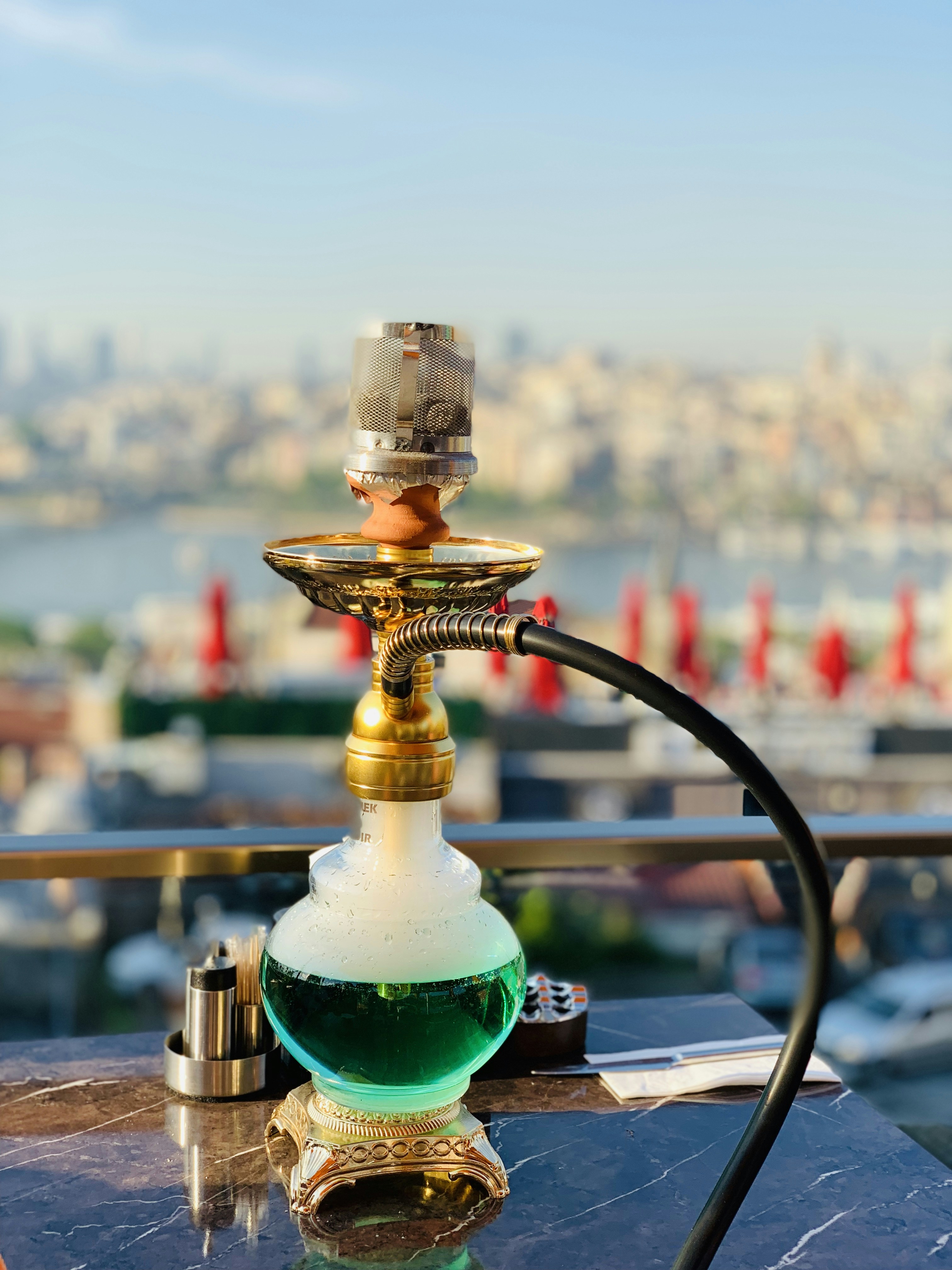 Hookah on the Balcony: Glass Globe with Cityscape in the Background