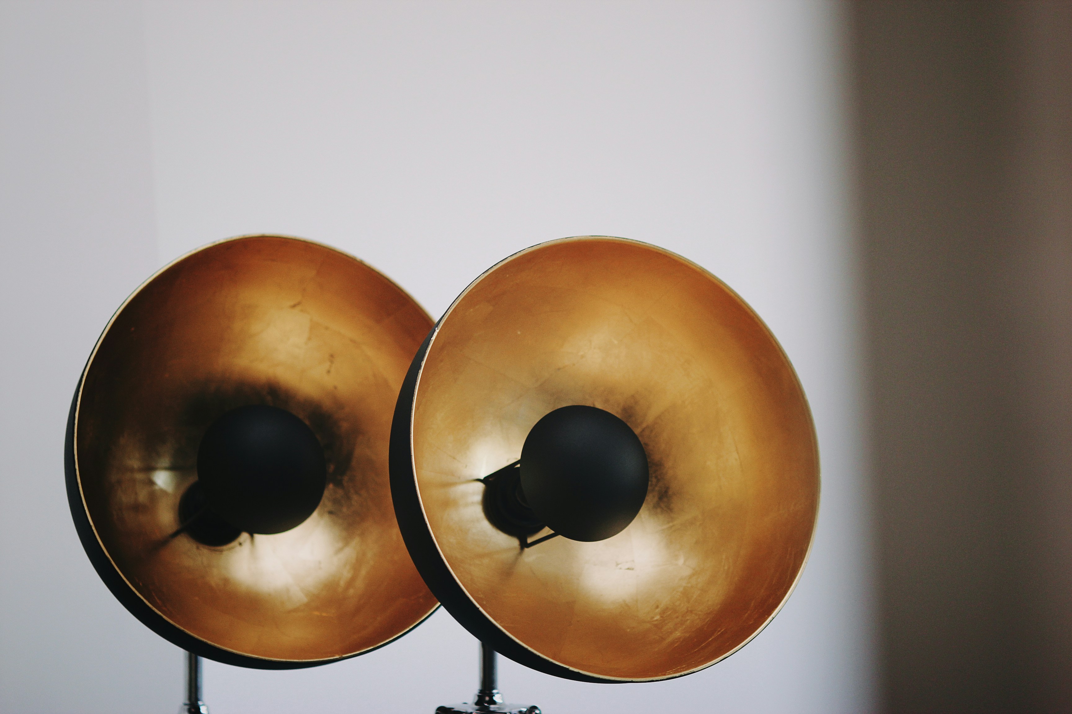 Twin Copper Dish Lights in a Minimal Studio Glow