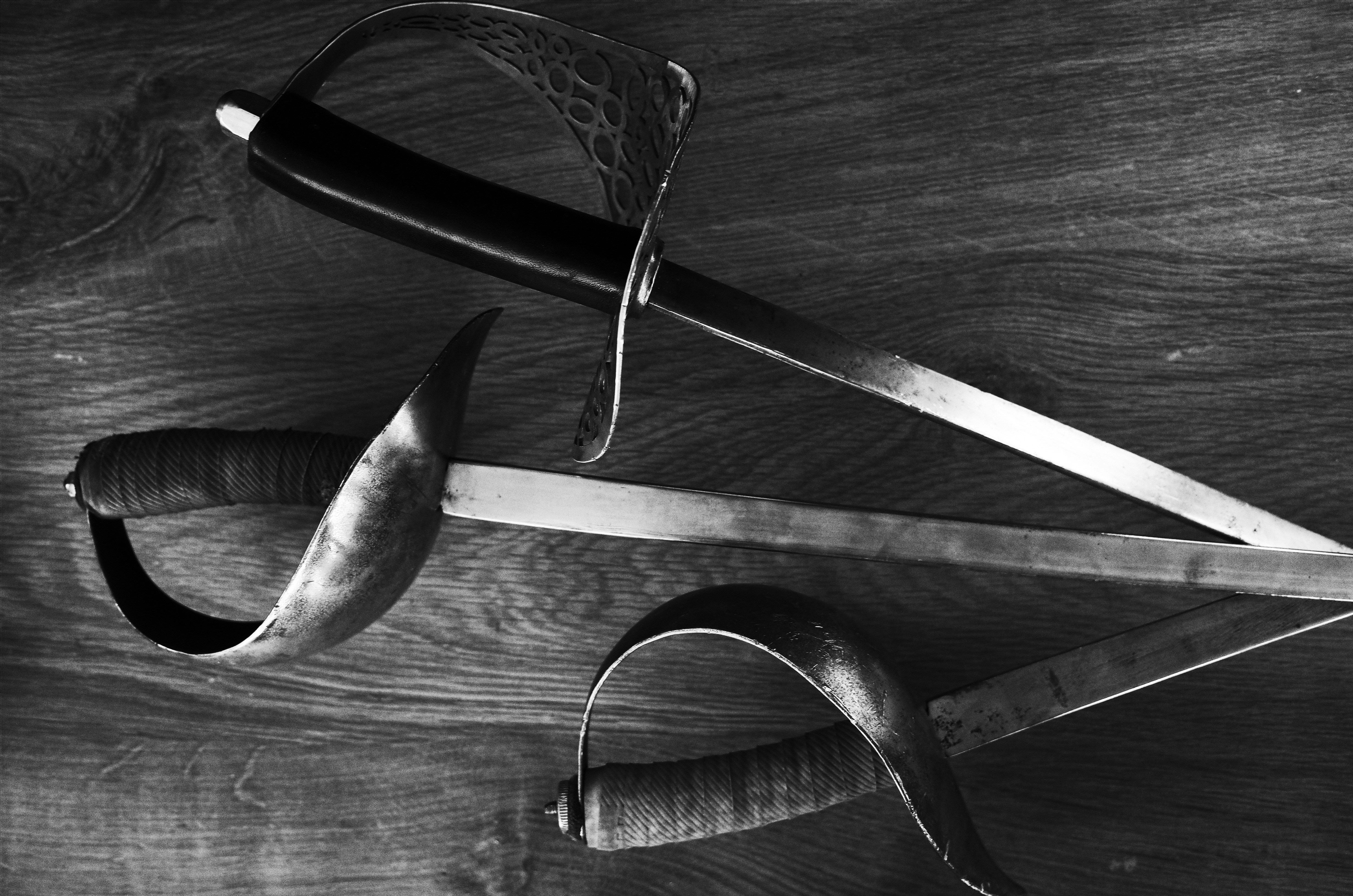 Crossed Blades on Weathered Wood: A Quiet Steel Study