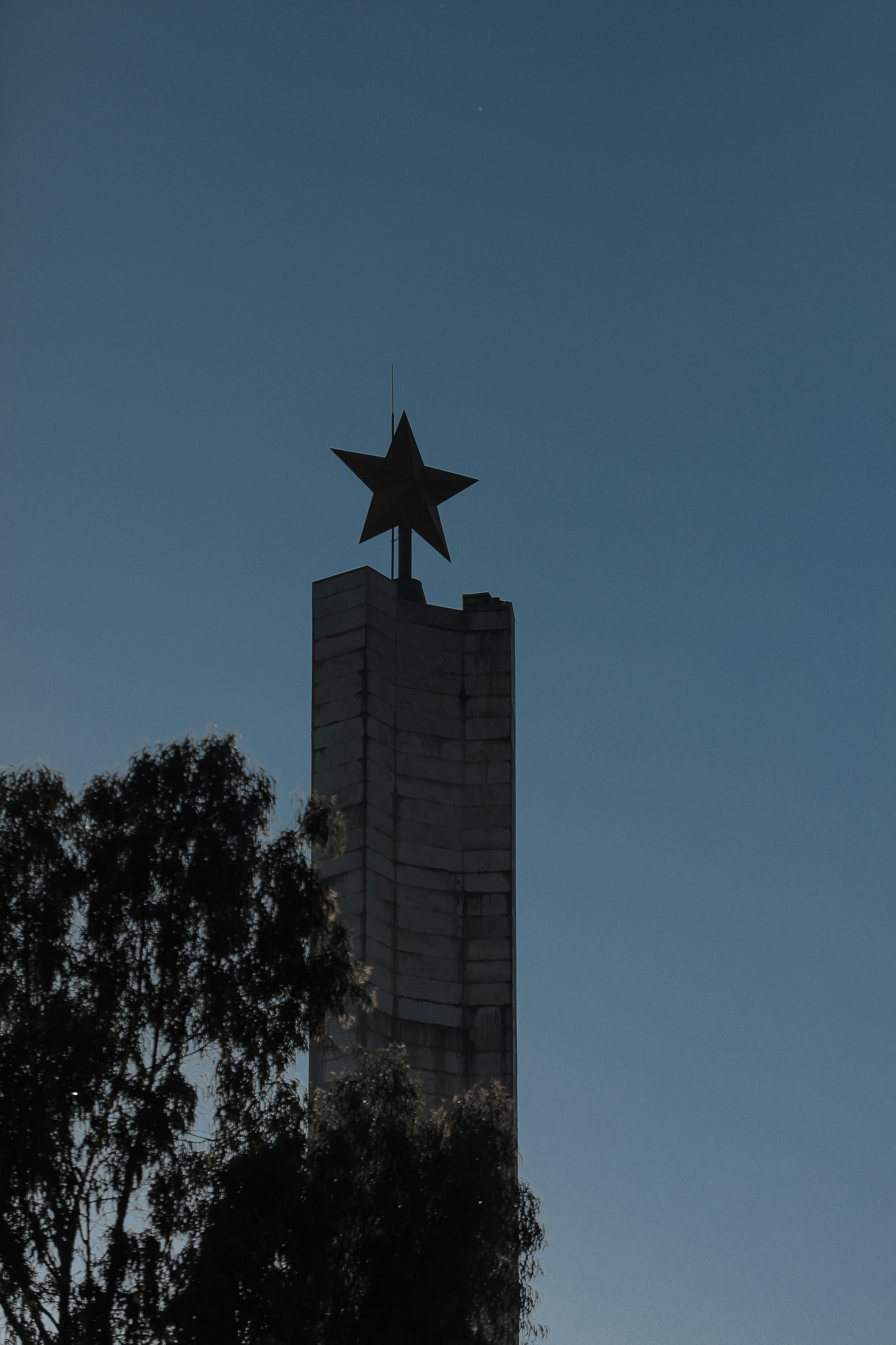 Star Crown Over a Monolithic Tower at Dusk