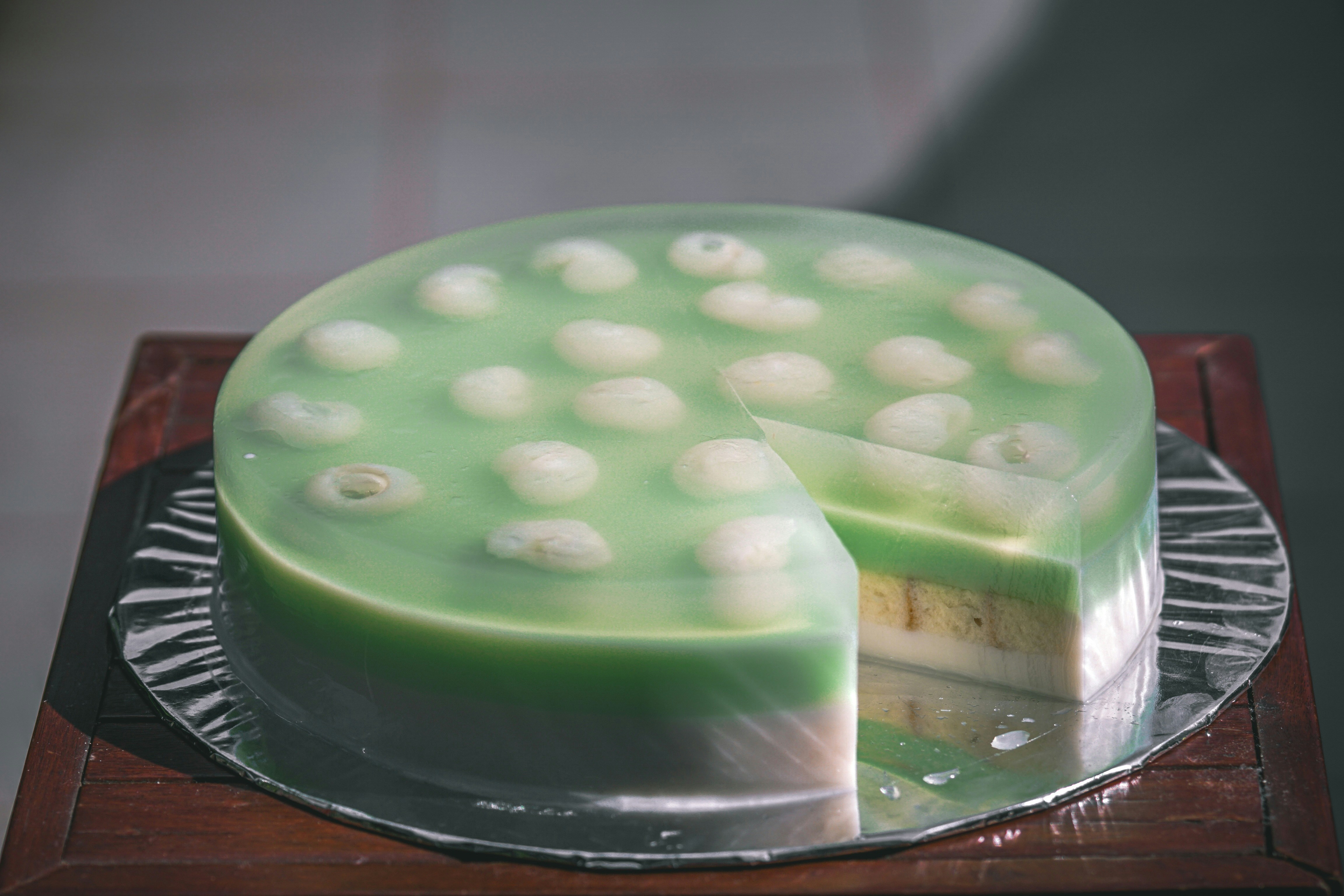 Pistachio Mirror Glaze Cake: A Slice Revealing Creamy Layers