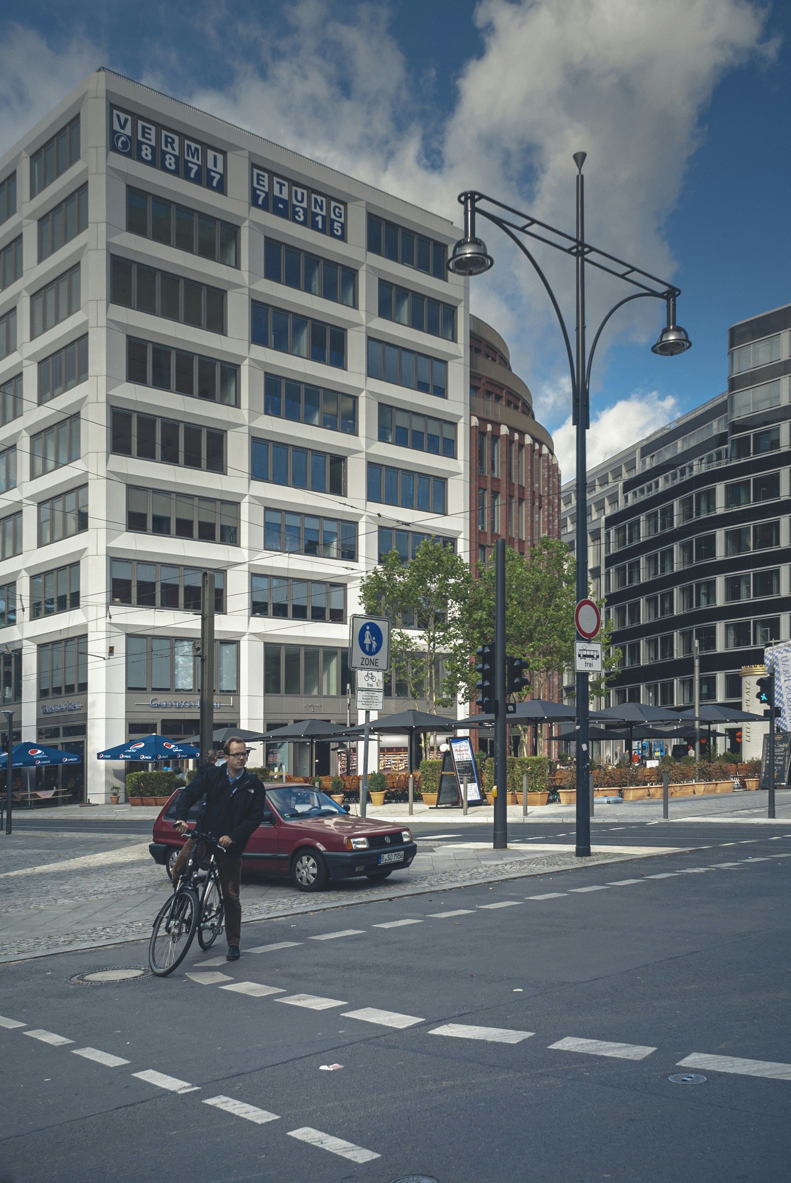 Urban Confluence: Cyclist at the Edge of Glass Towers