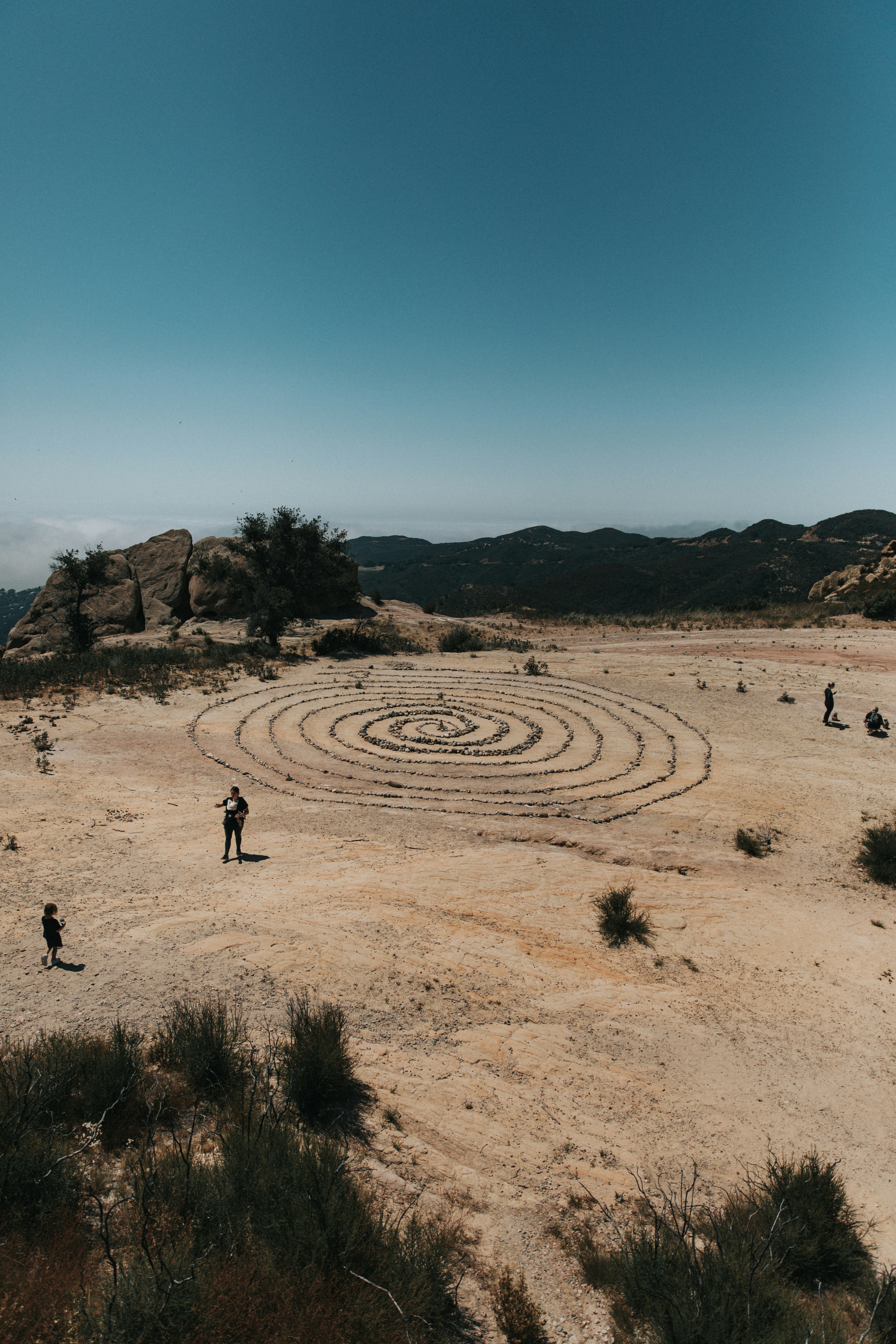 people walking on brown field during daytime