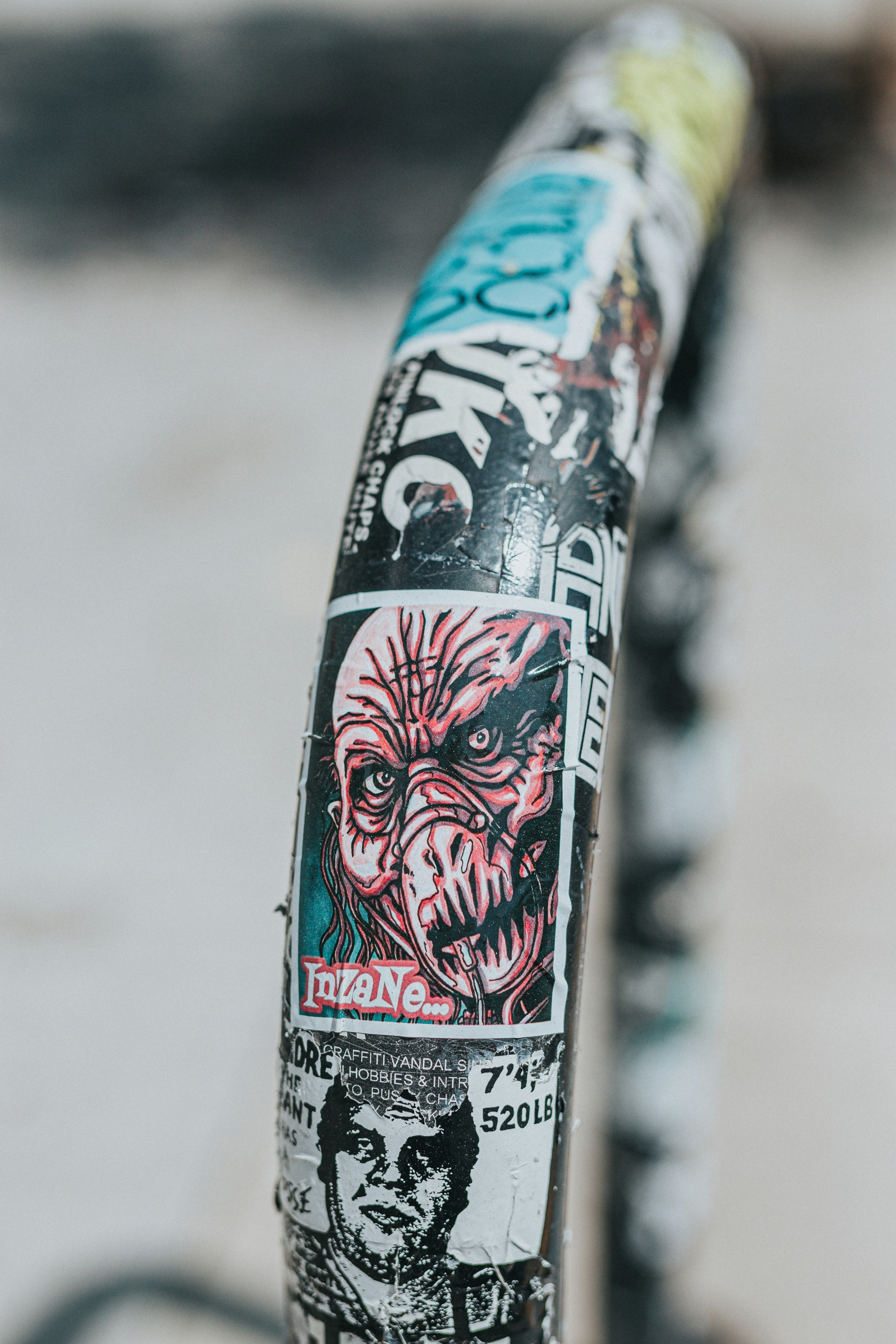Demon Portrait on a Stickered Bicycle Frame: A Close-Up