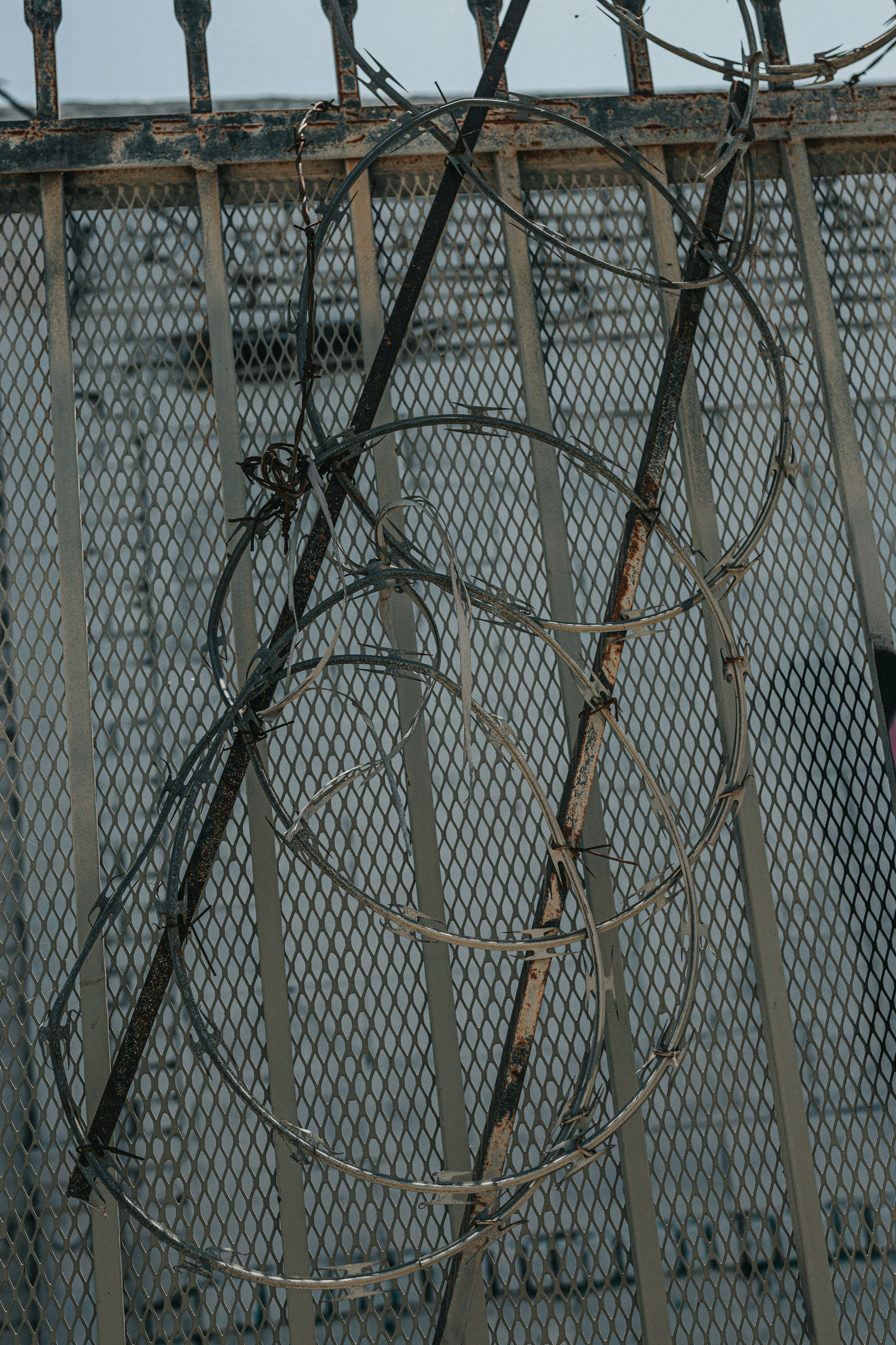 black metal fence near white concrete building during daytime