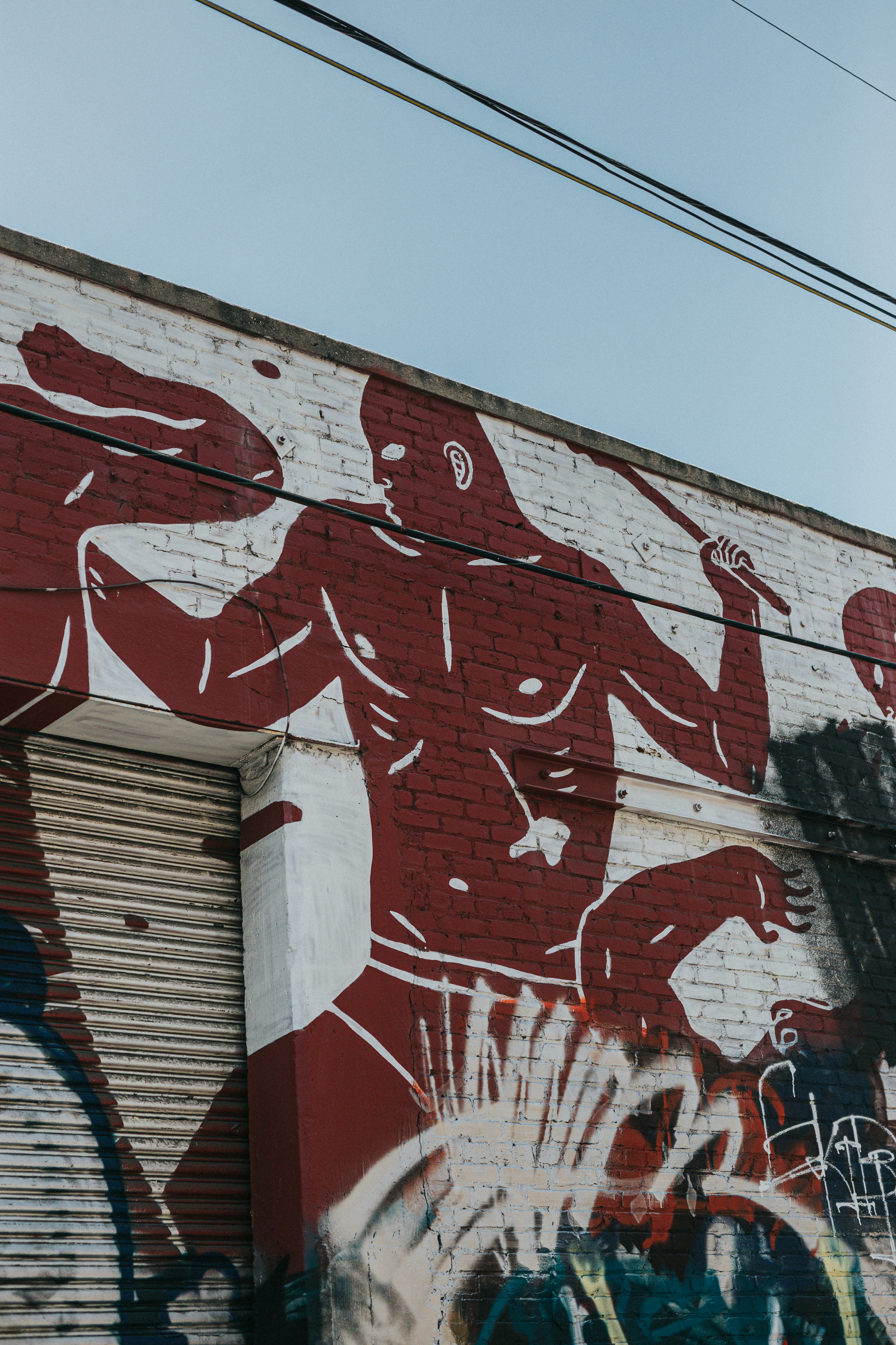 Red and white graffiti on wall photo – Free Graffiti Image on Unsplash