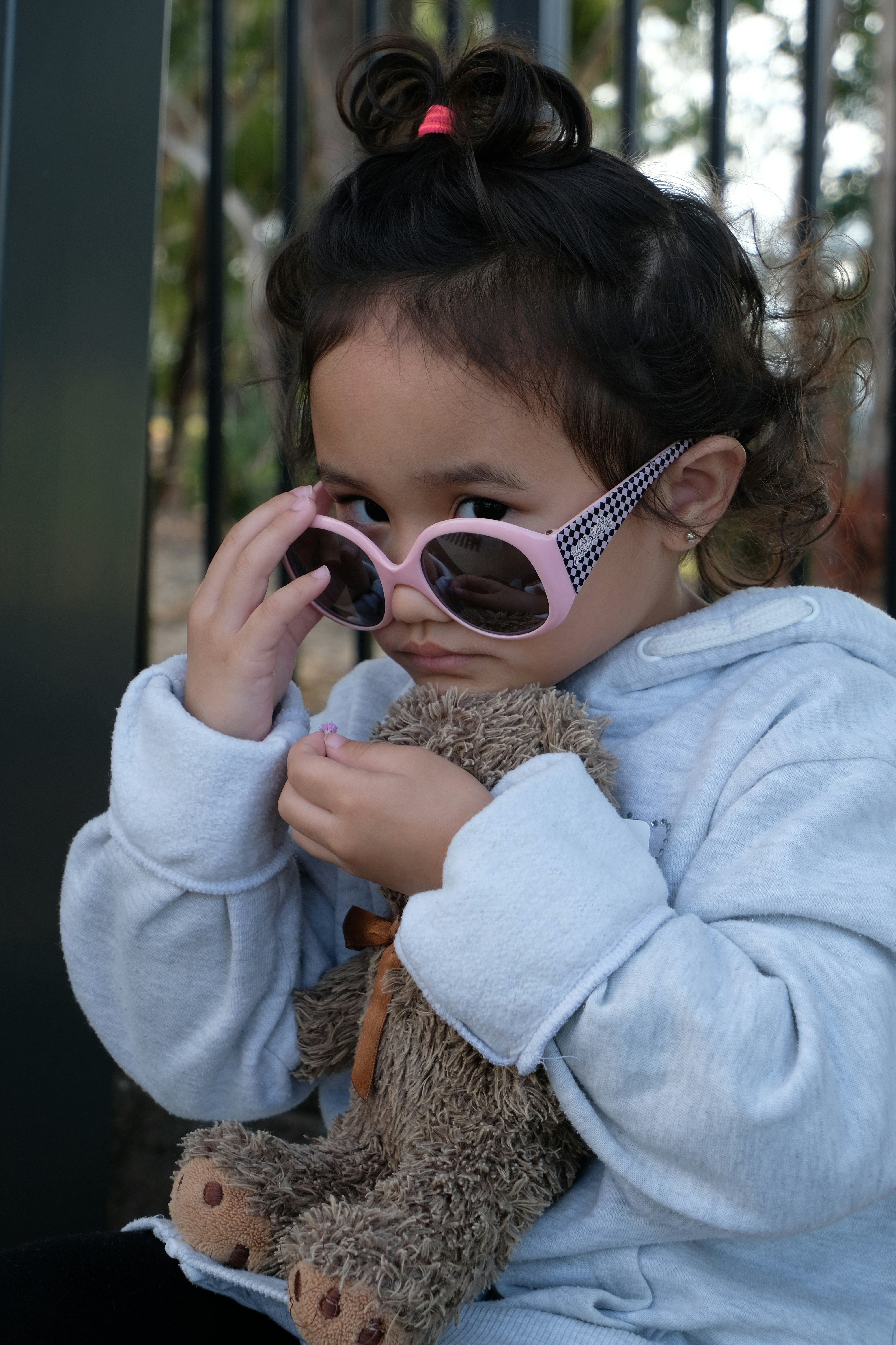 Pink-Tinted Confidence: A Curious Moment with a Teddy Bear
