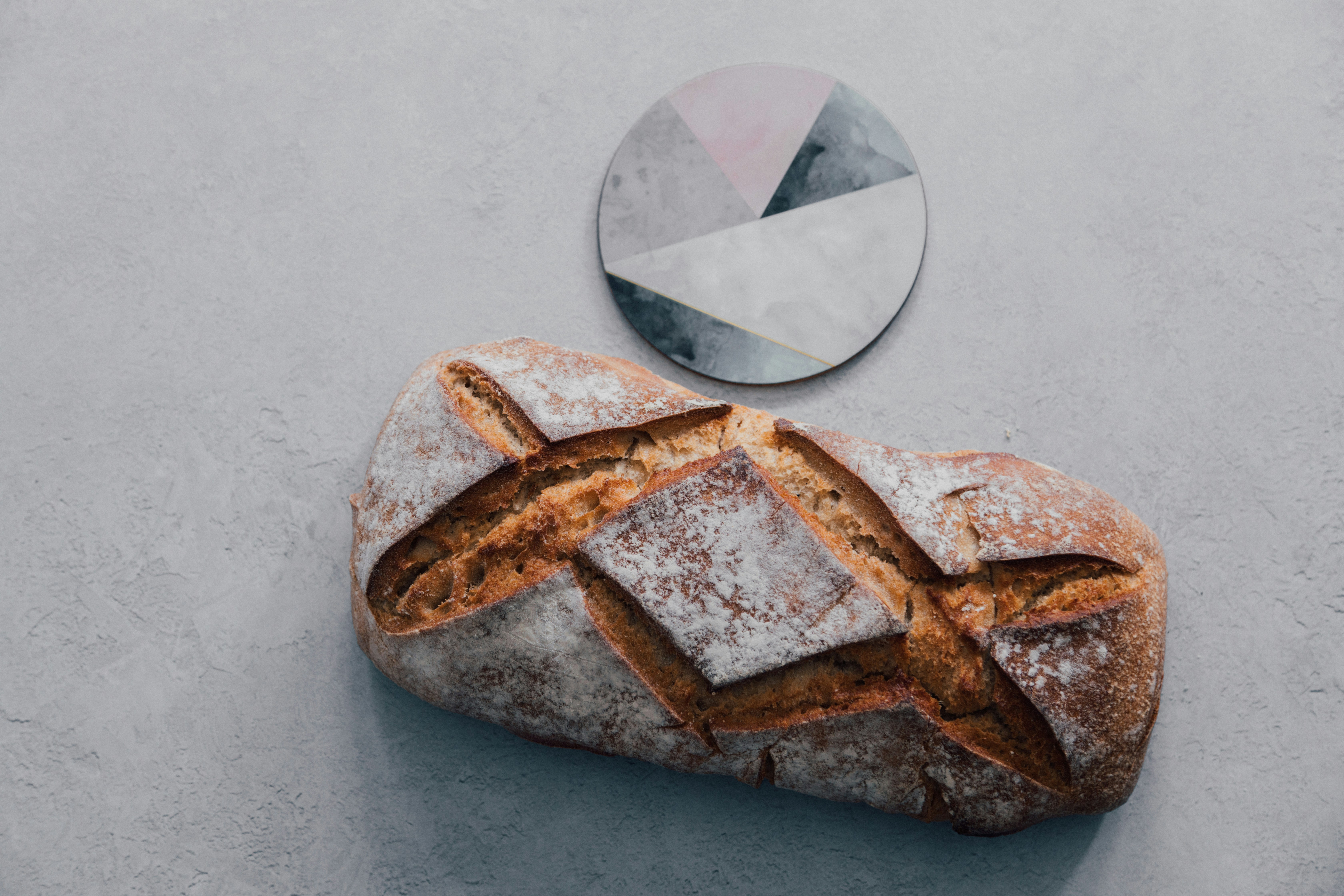 Crackled Crust, Quiet Geometry: An Artisanal Loaf on Slate
