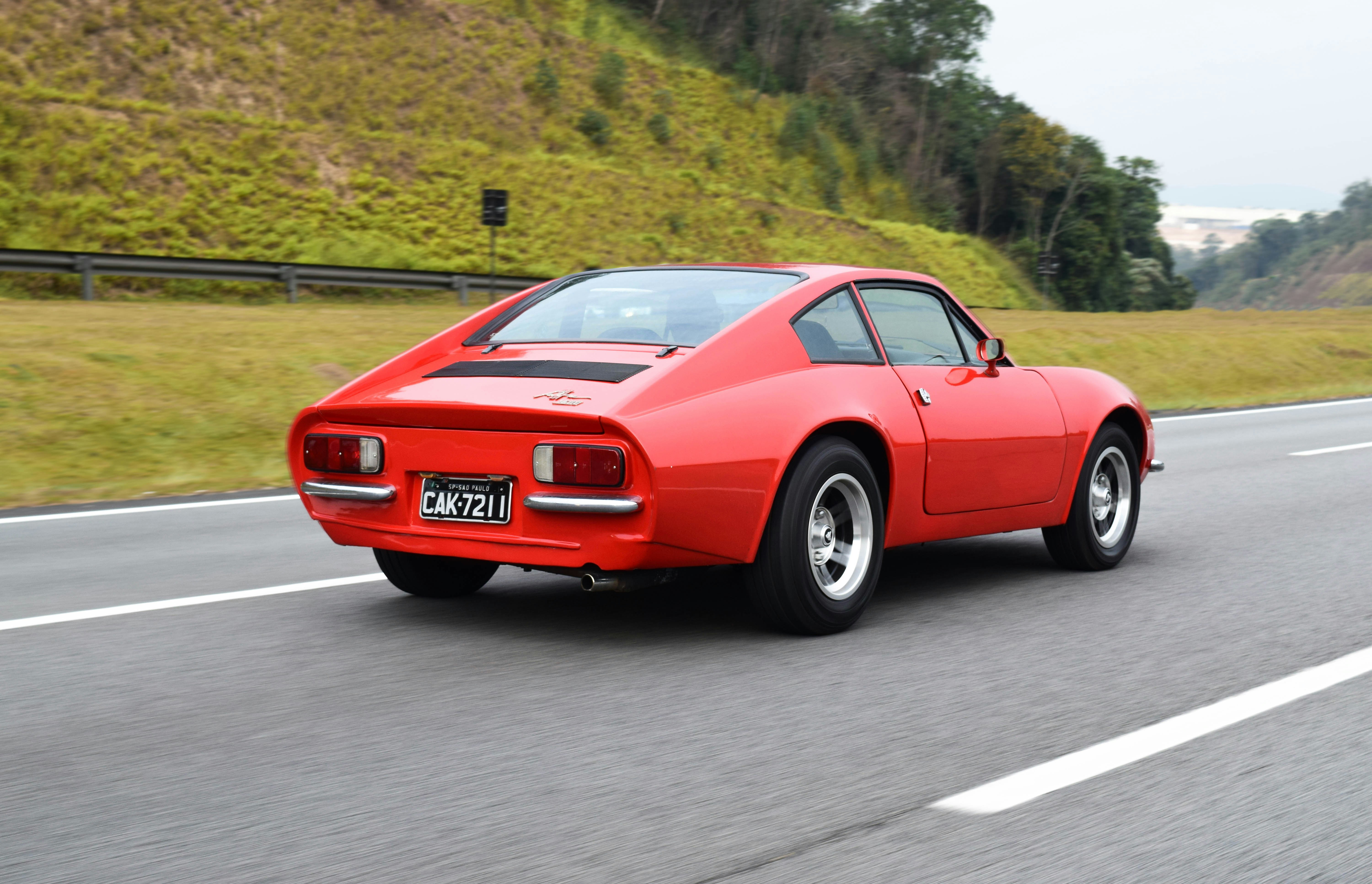 Classic Red Sports Car on Scenic Highway