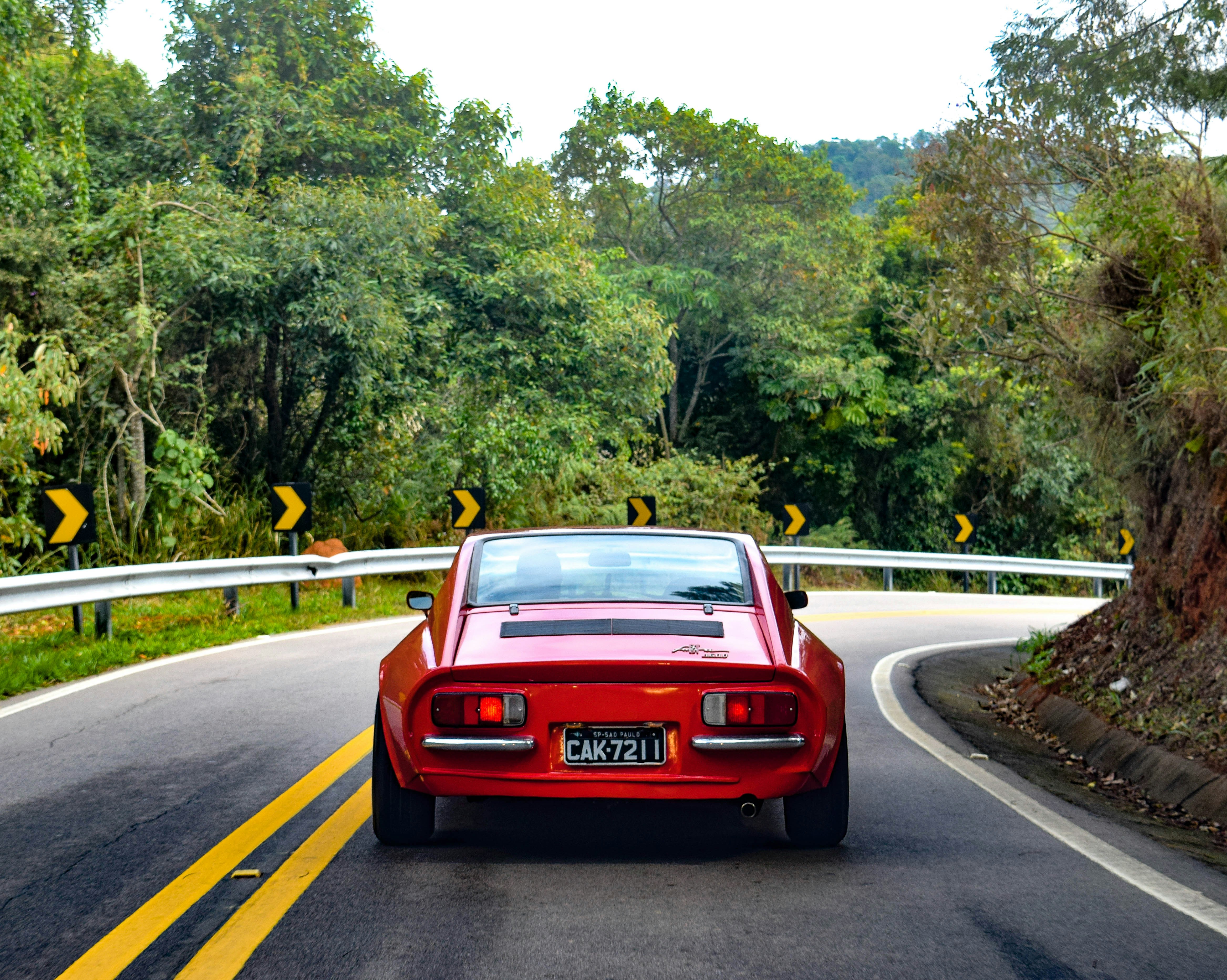 Red Roadster Bites the Curve on a Mountain Hairpin