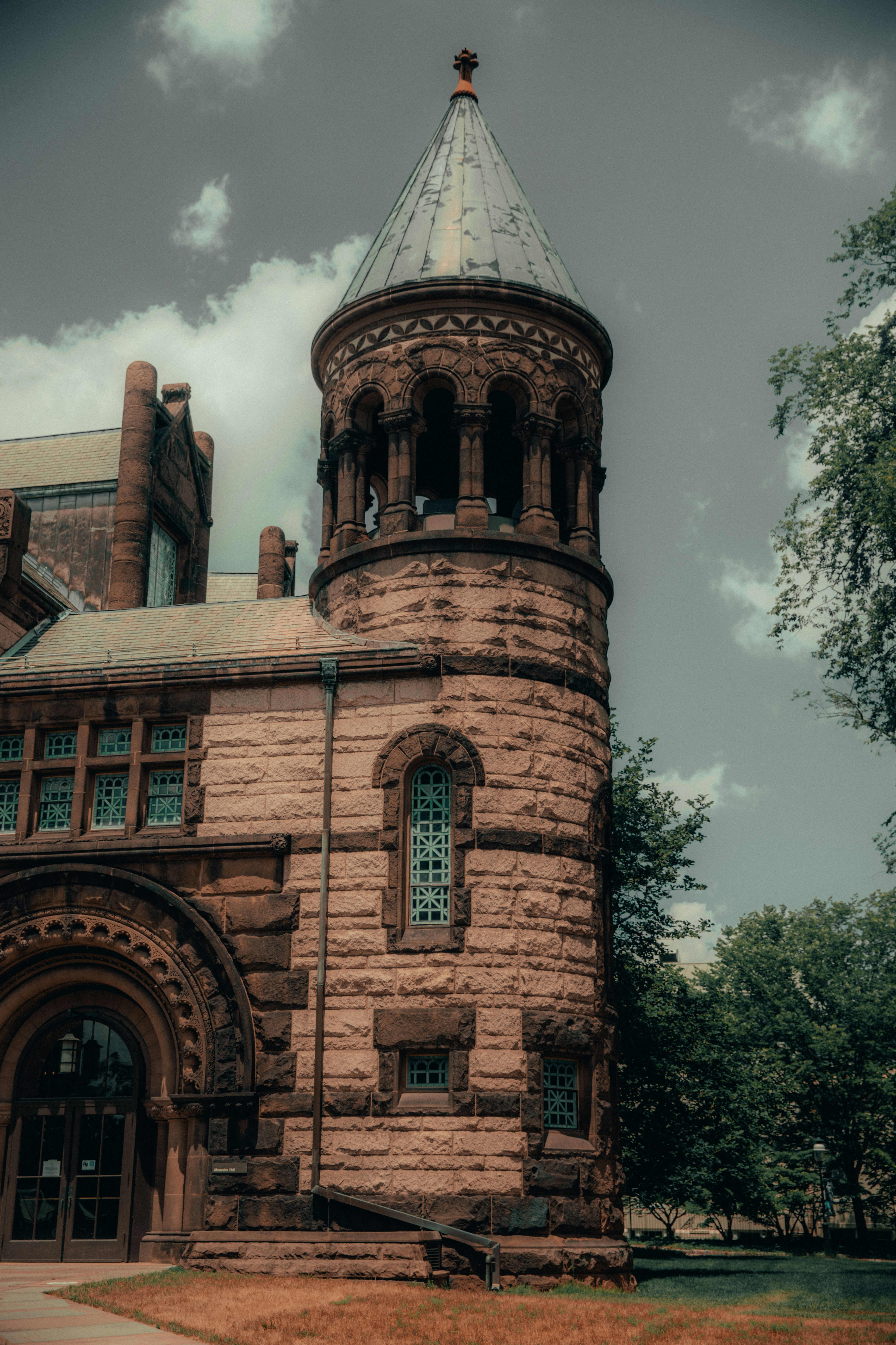 Timeworn Turret Rising from Red Brick: Quiet Light on a Historic Facade