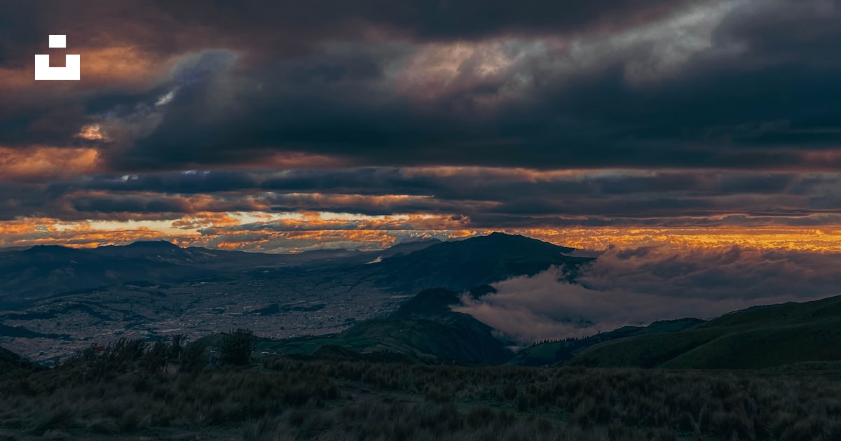 Green Grass Field Near Body Of Water During Sunset Photo Free Quito