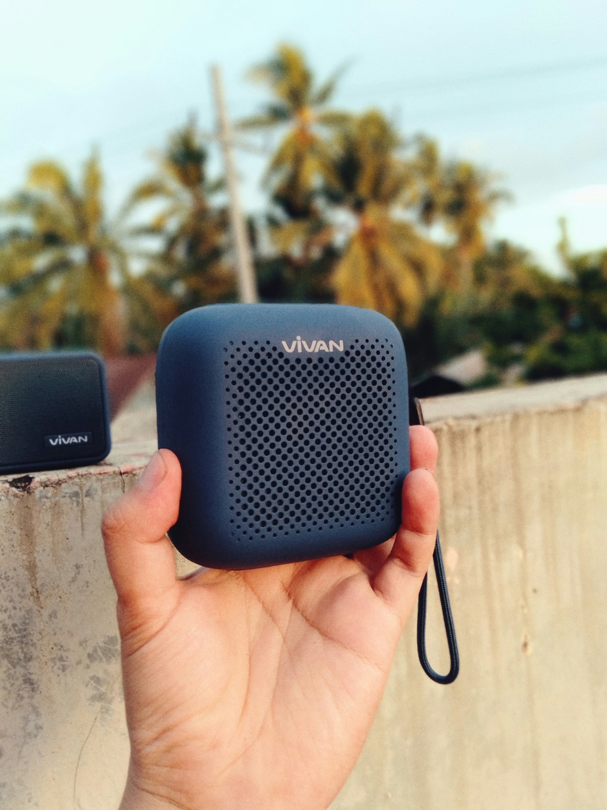 Compact Speaker in Hand: A Portable Moment with Palm-Size Audio